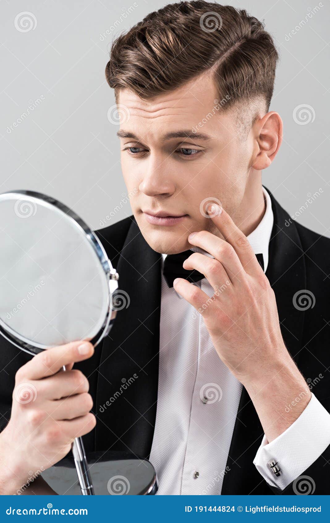 Man in Formal Wear Looking in Mirror and Touching Face Isolated on Grey ...