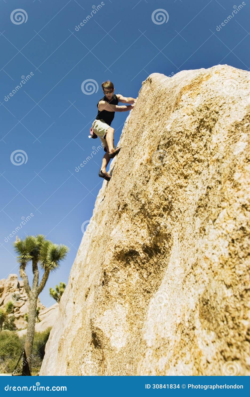 Man Free Climbing on Cliff stock photo. Image of active - 30841834
