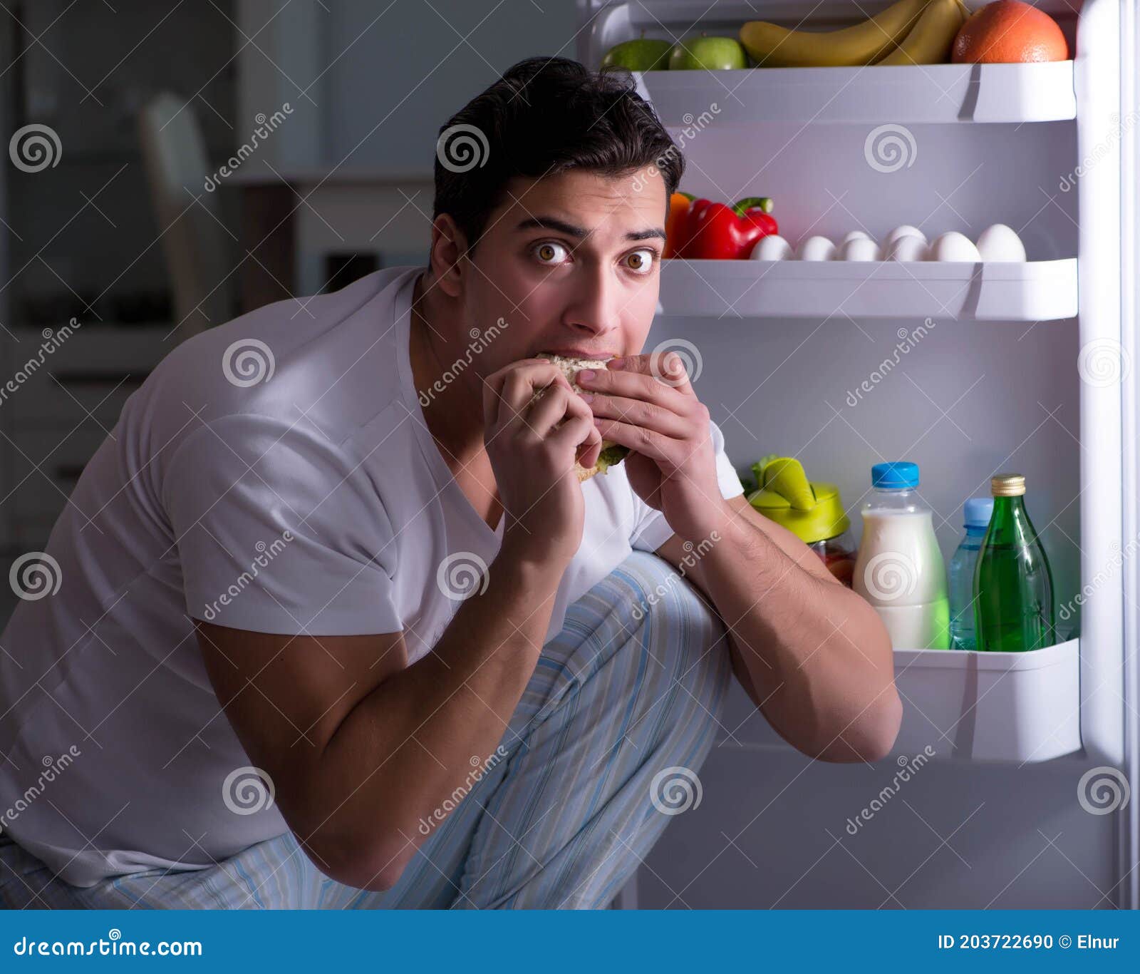 Man at the Fridge Eating at Night Stock Photo - Image of eating ...