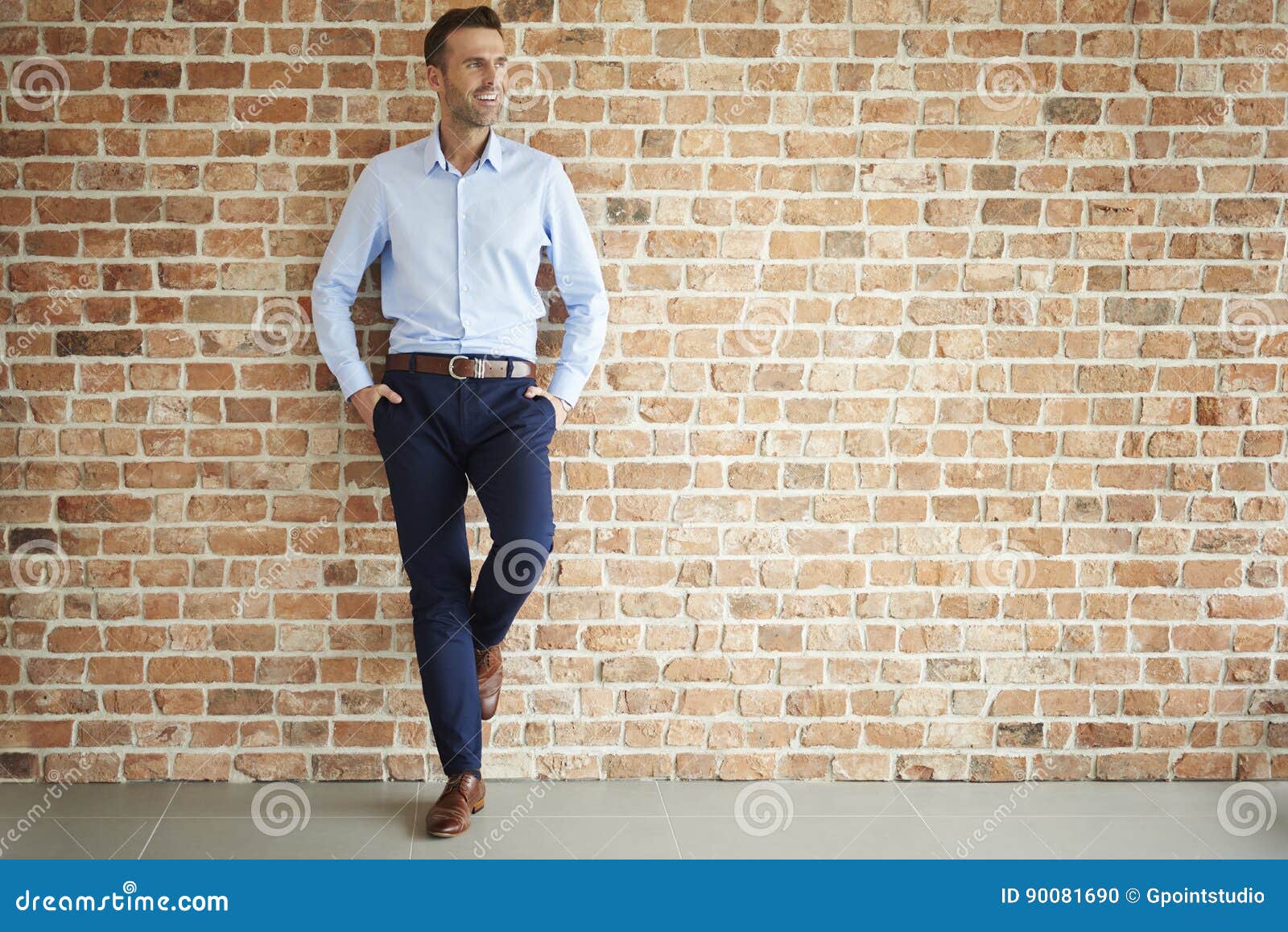 Man in front of brick wall stock photo. Image of formal - 90081690