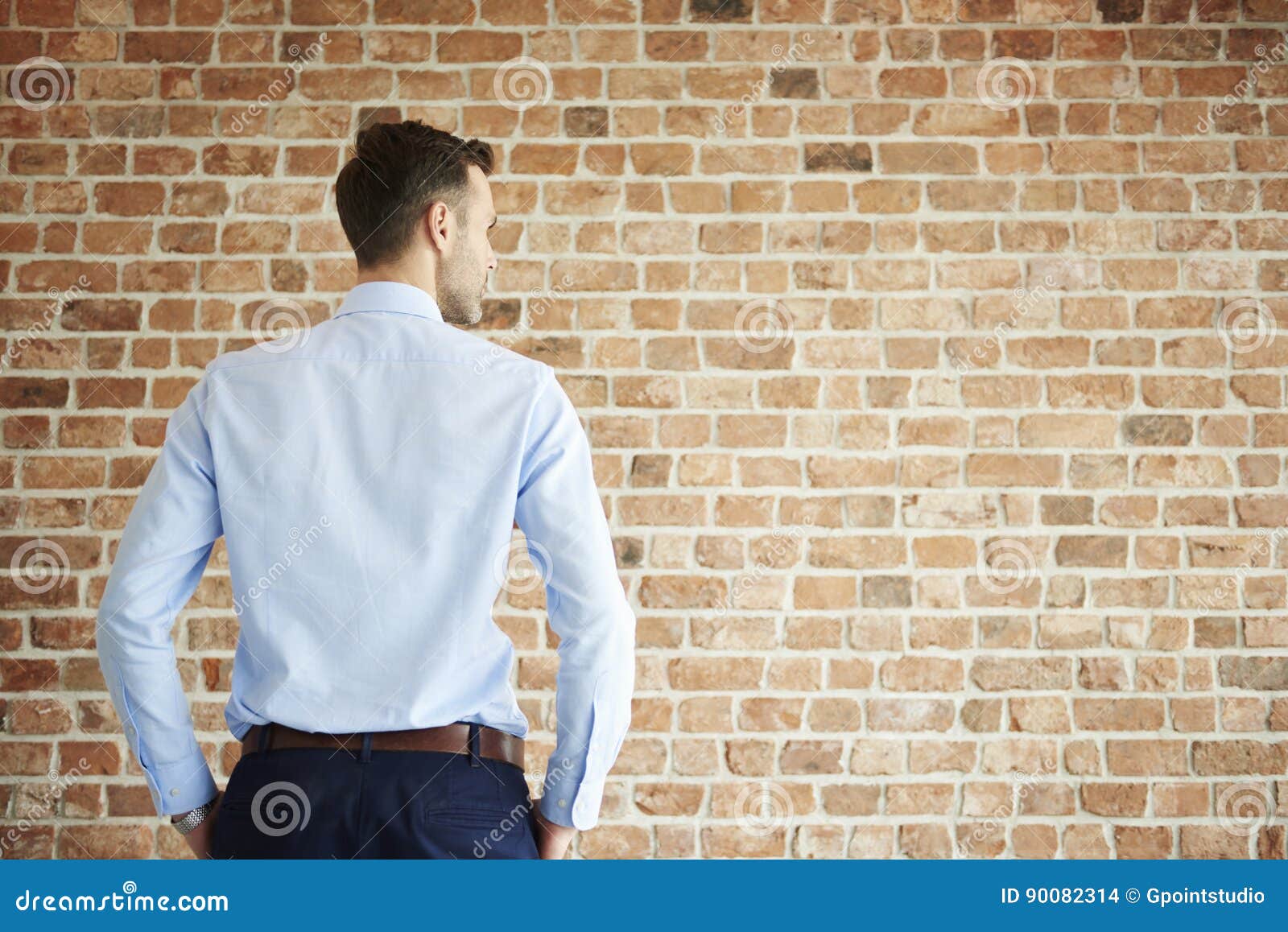 Man in front of brick wall stock photo. Image of business - 90082314