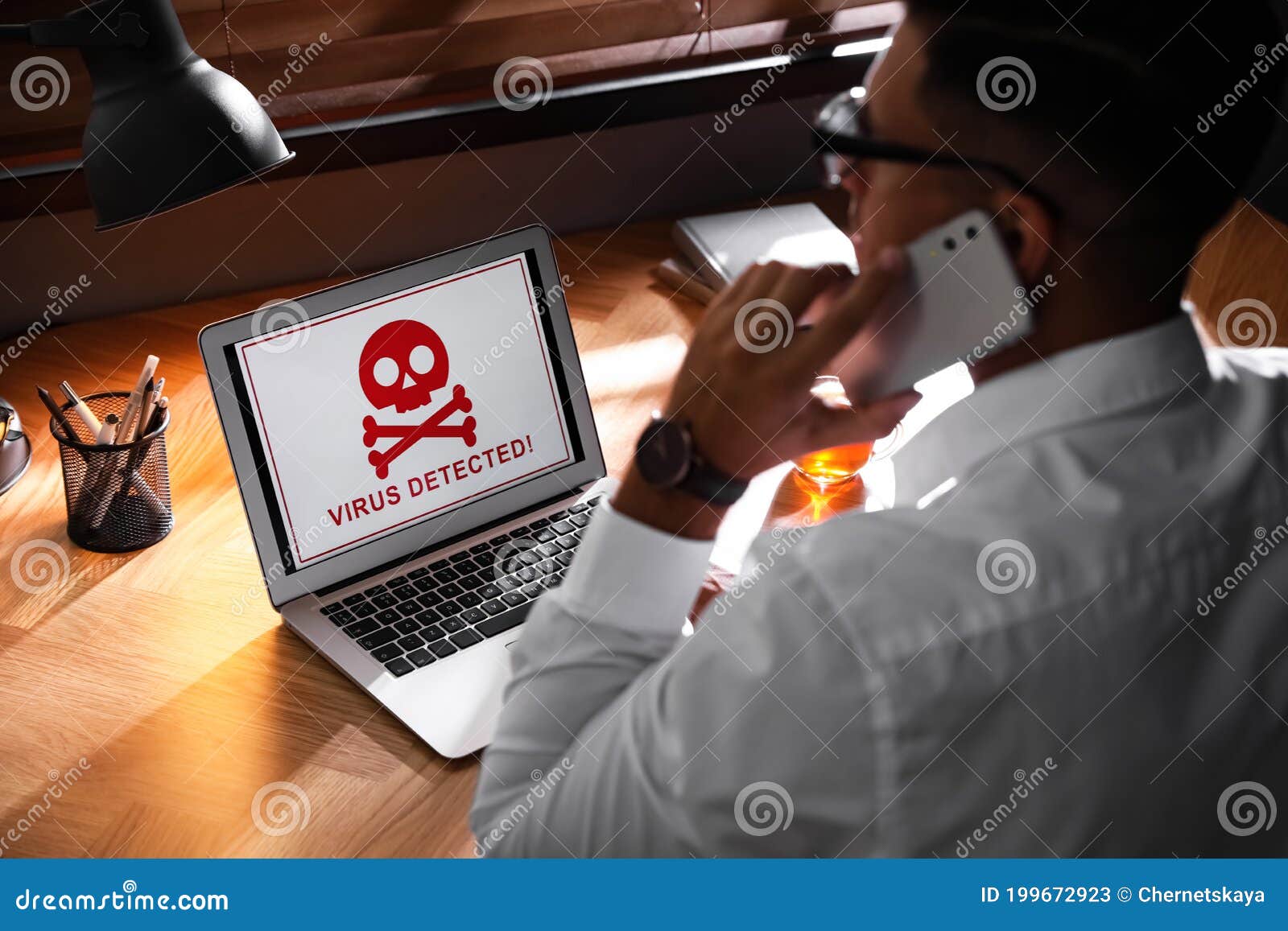 Man in Front of Laptop with Warning about Virus Attack at Workplace ...