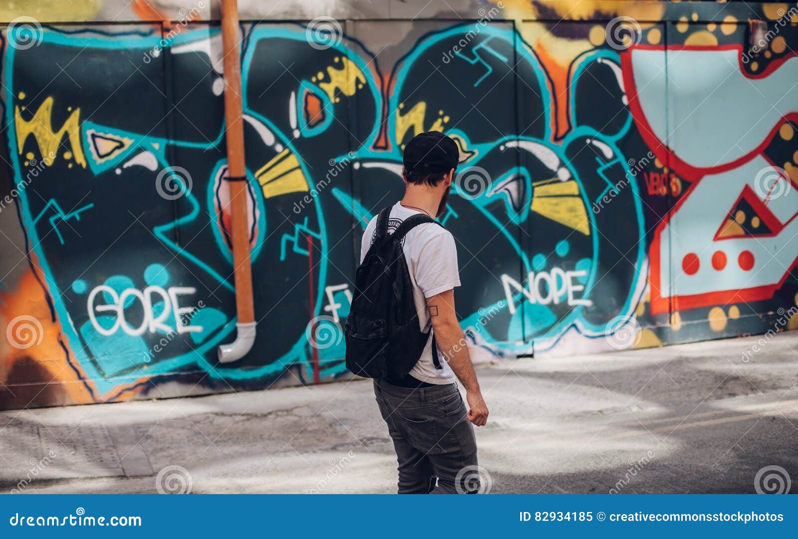 Man In Front Of Wall With Graffiti Picture. Image: 82934185