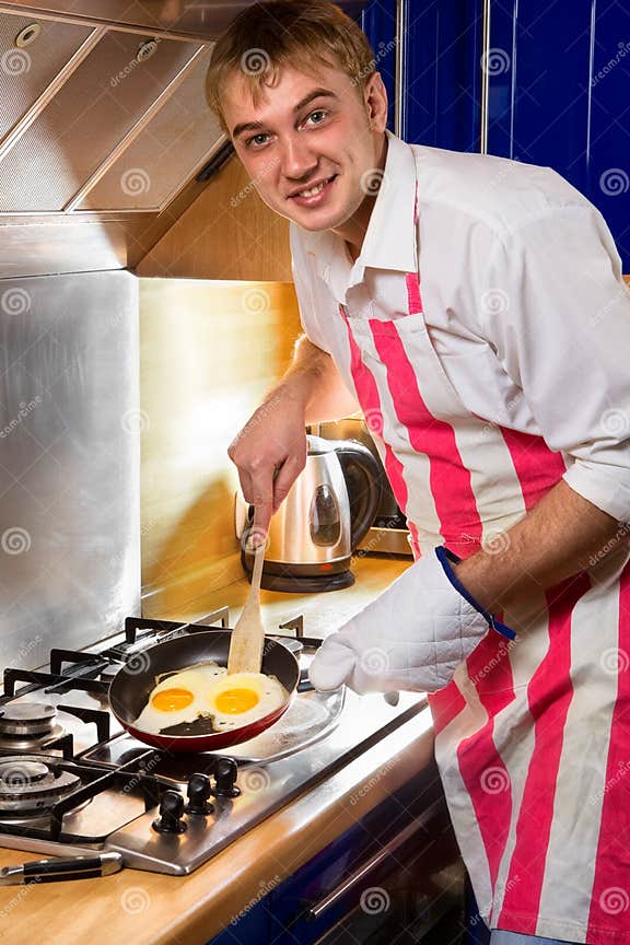 Man frying eggs stock photo. Image of stove, preparation - 23660832
