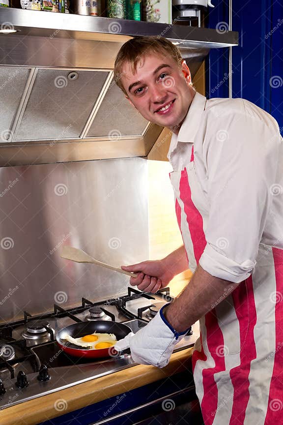 Man frying eggs stock photo. Image of playful, indoor - 29437470