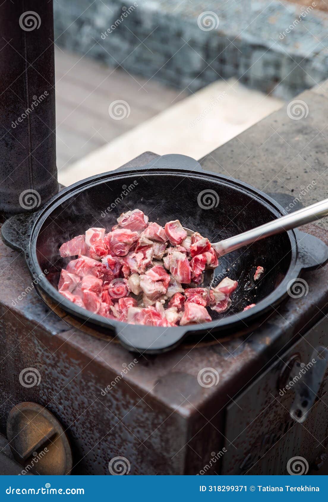 Man Frying Pork and Beef Meat in a Cauldron in the Backyard Stock Image ...