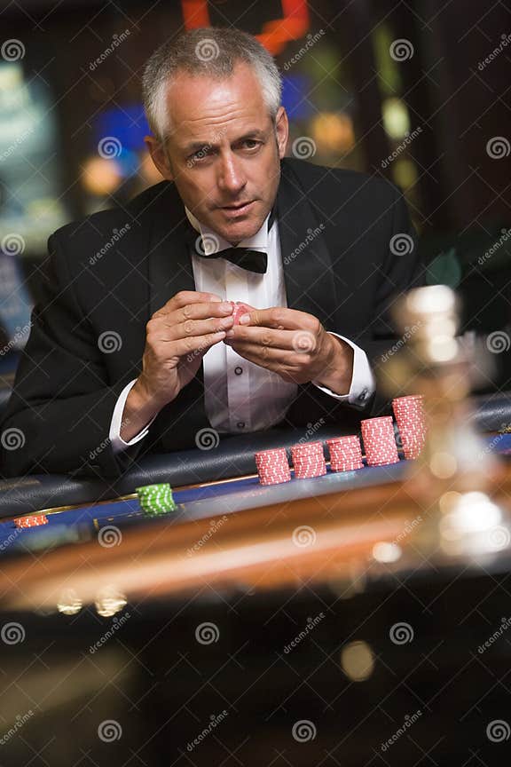 Man Gambling at Roulette Table Stock Photo - Image of mature, person ...