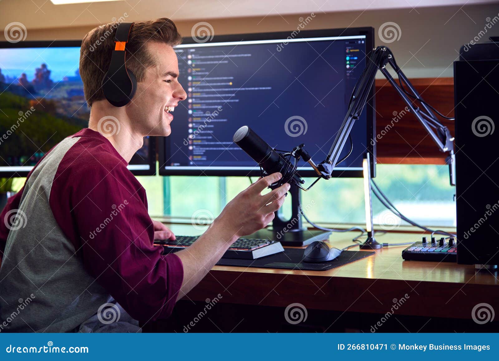 Man Gaming at Home Sitting at Desk with Multiple Monitors Stock Image ...