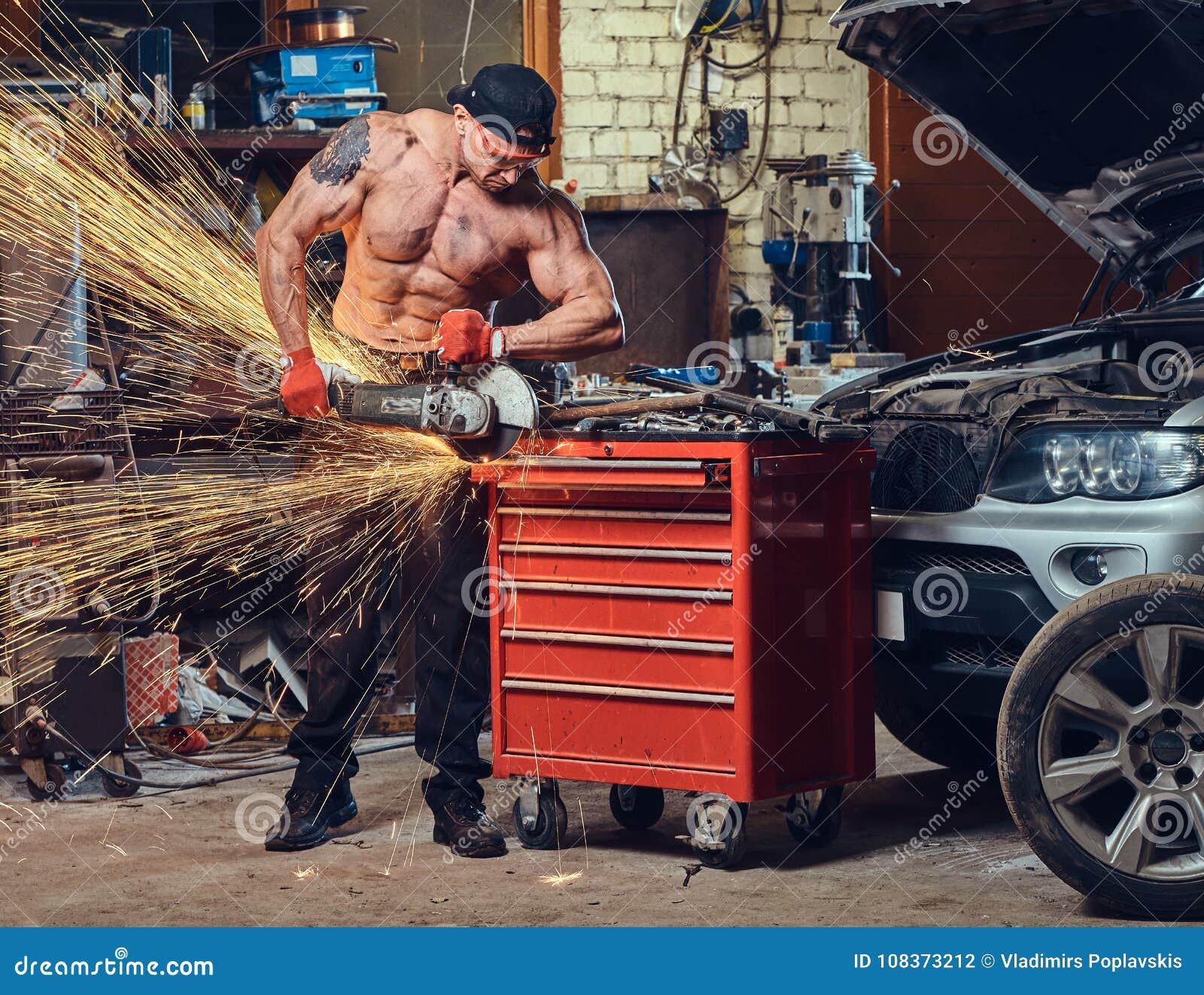 A man in a garage. stock photo. Image of circular, rotary - 108373212
