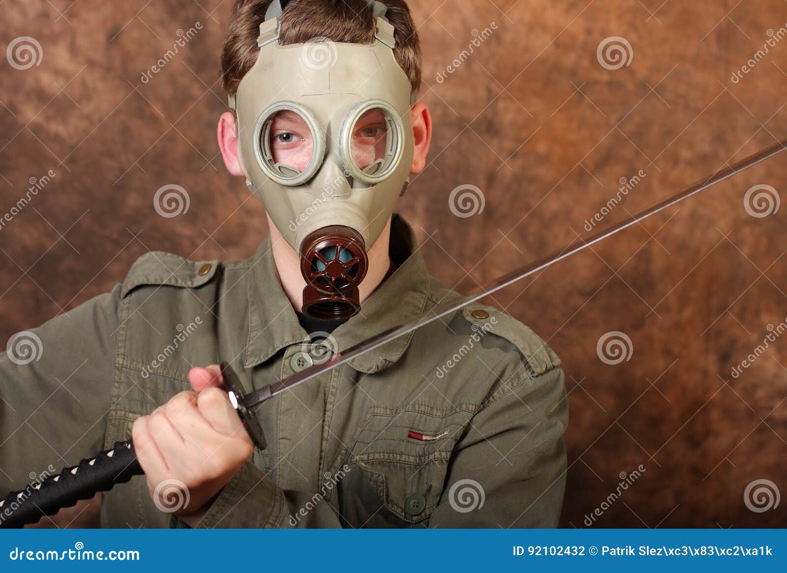 Man With Gas Mask And Katana Sword On Brown Batik Background Stock ...