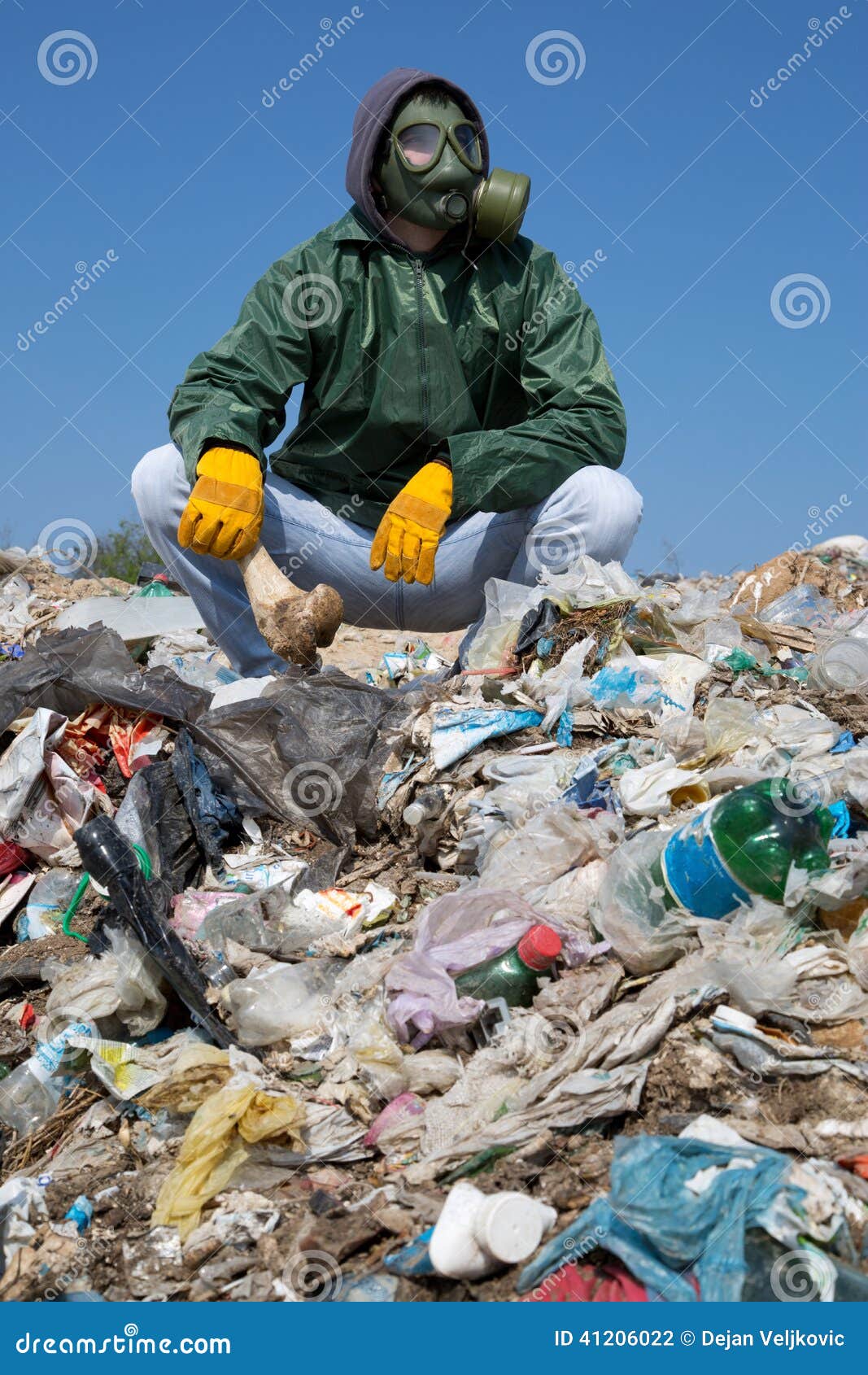 Man in a Gas Mask Sitting on the Garbage and Holding a Bone Stock Photo ...