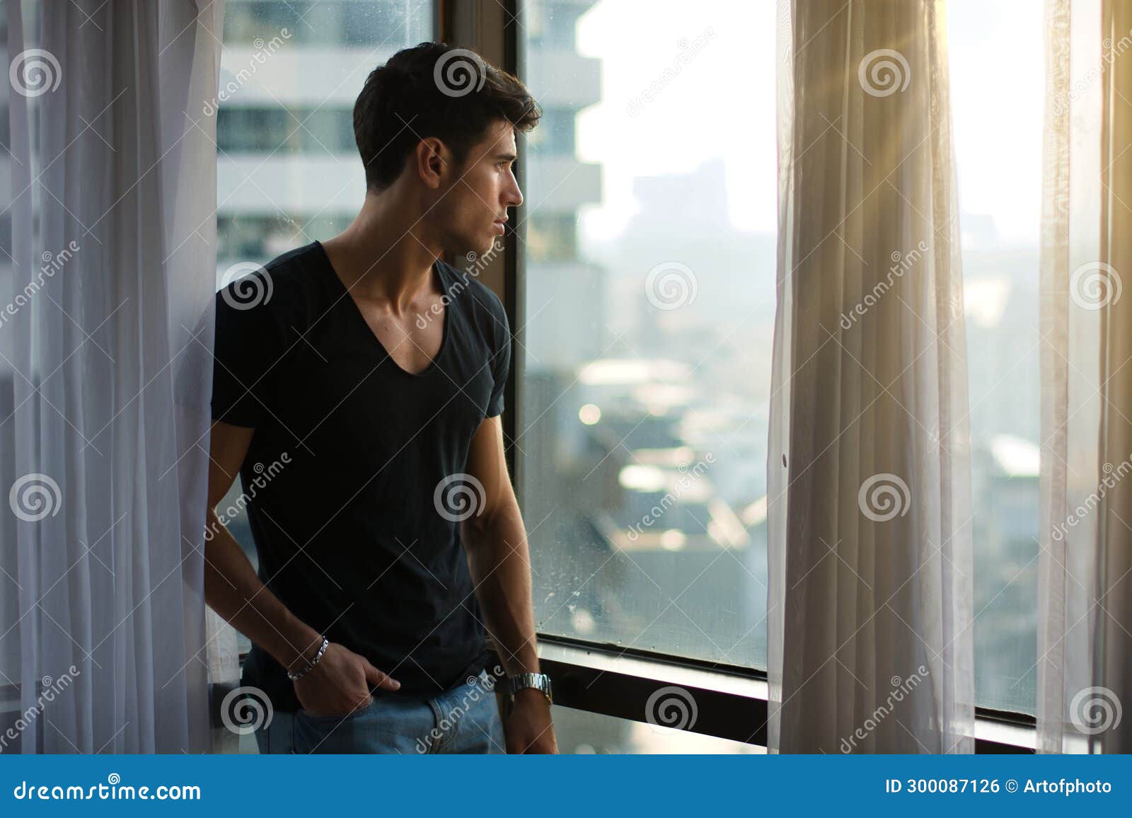 Man Gazing at Cityscape through Window Stock Photo - Image of ...