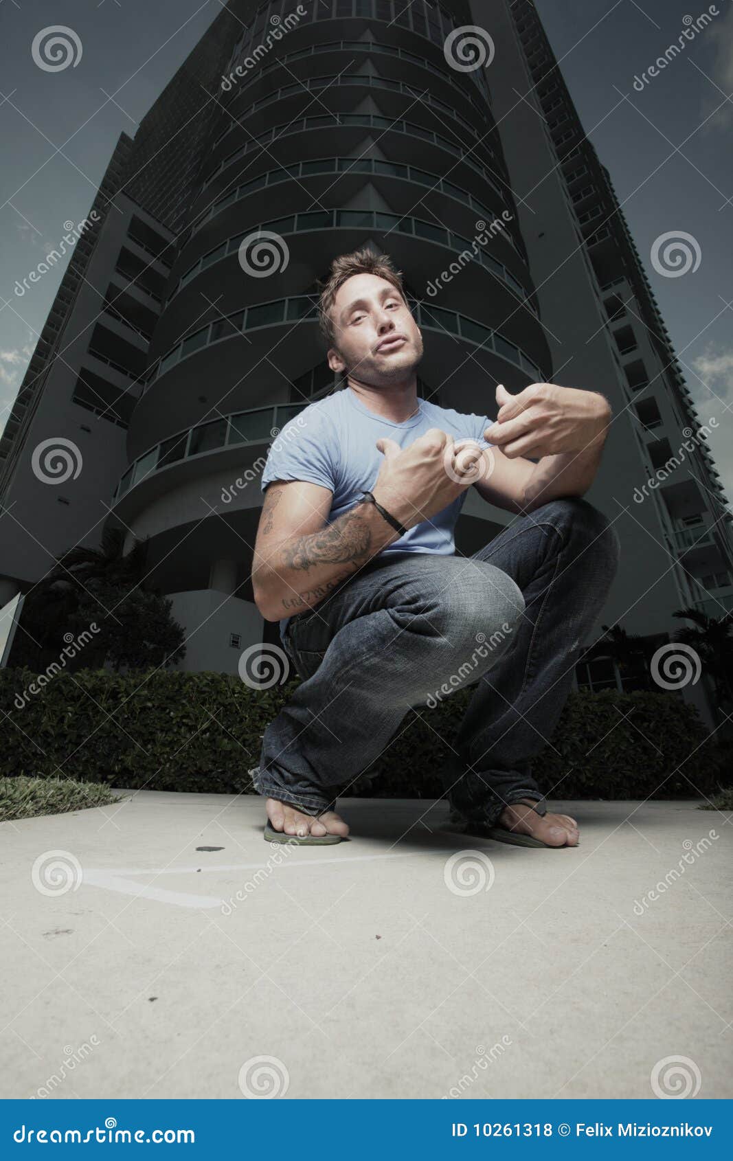 Man gesturing gang signs stock photo. Image of squatting - 10261318