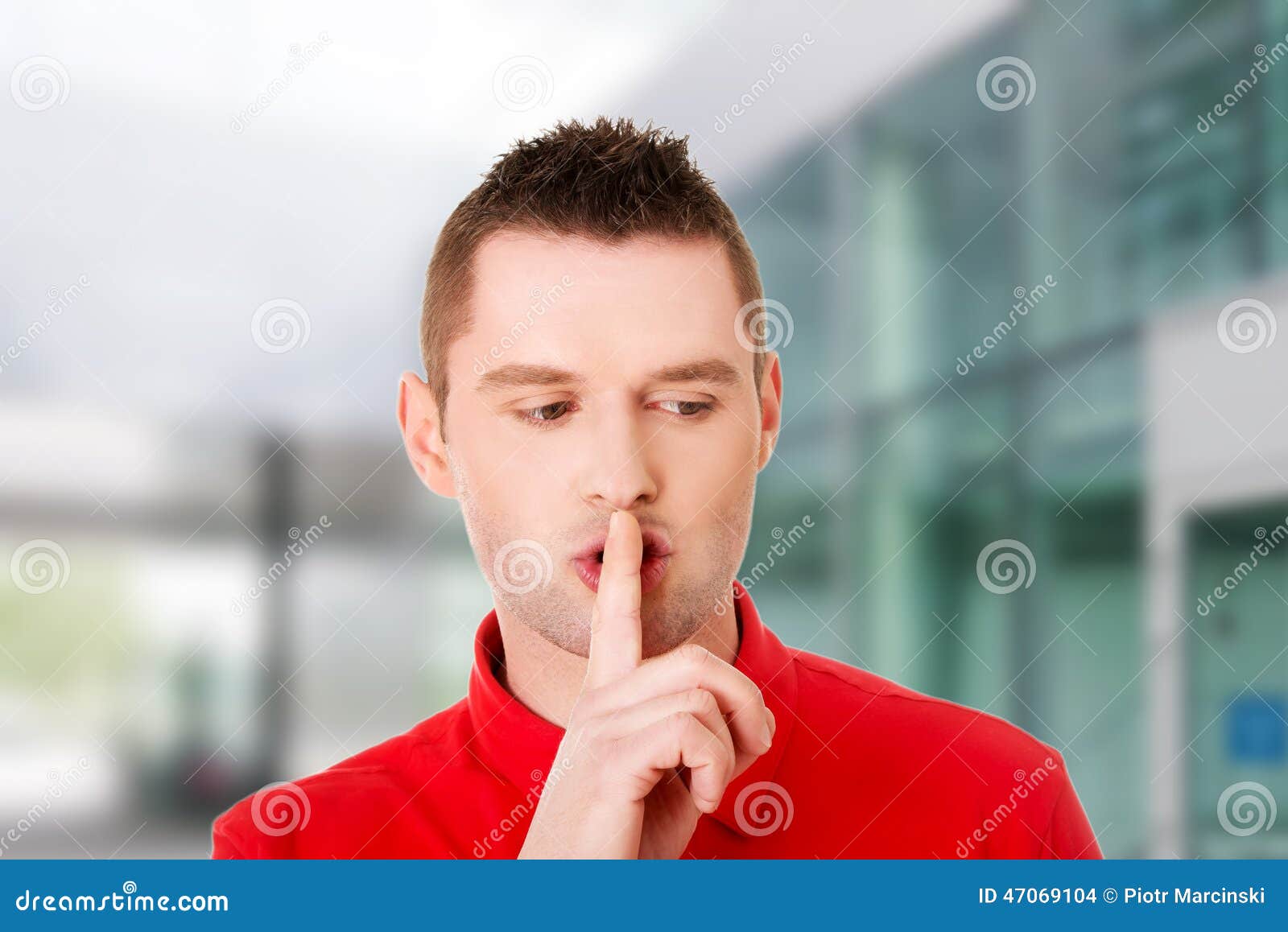 Man gesturing to be quiet stock photo. Image of beige - 47069104