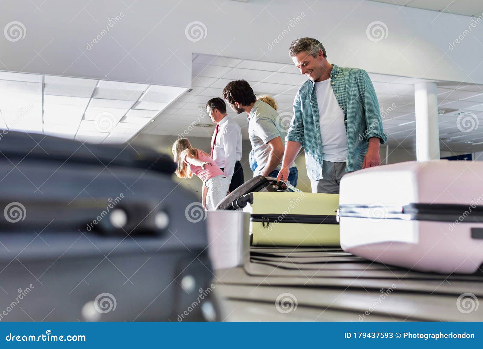 Man Getting His Suitcase on Baggage Claiming Area in Airport Stock ...