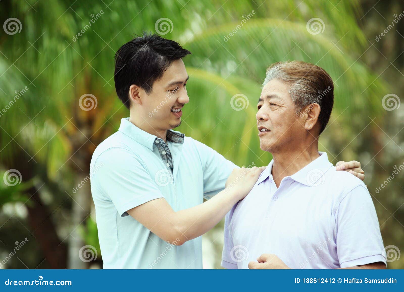 Man Giving His Father a Pat on the Shoulder while Talking. Conceptual ...