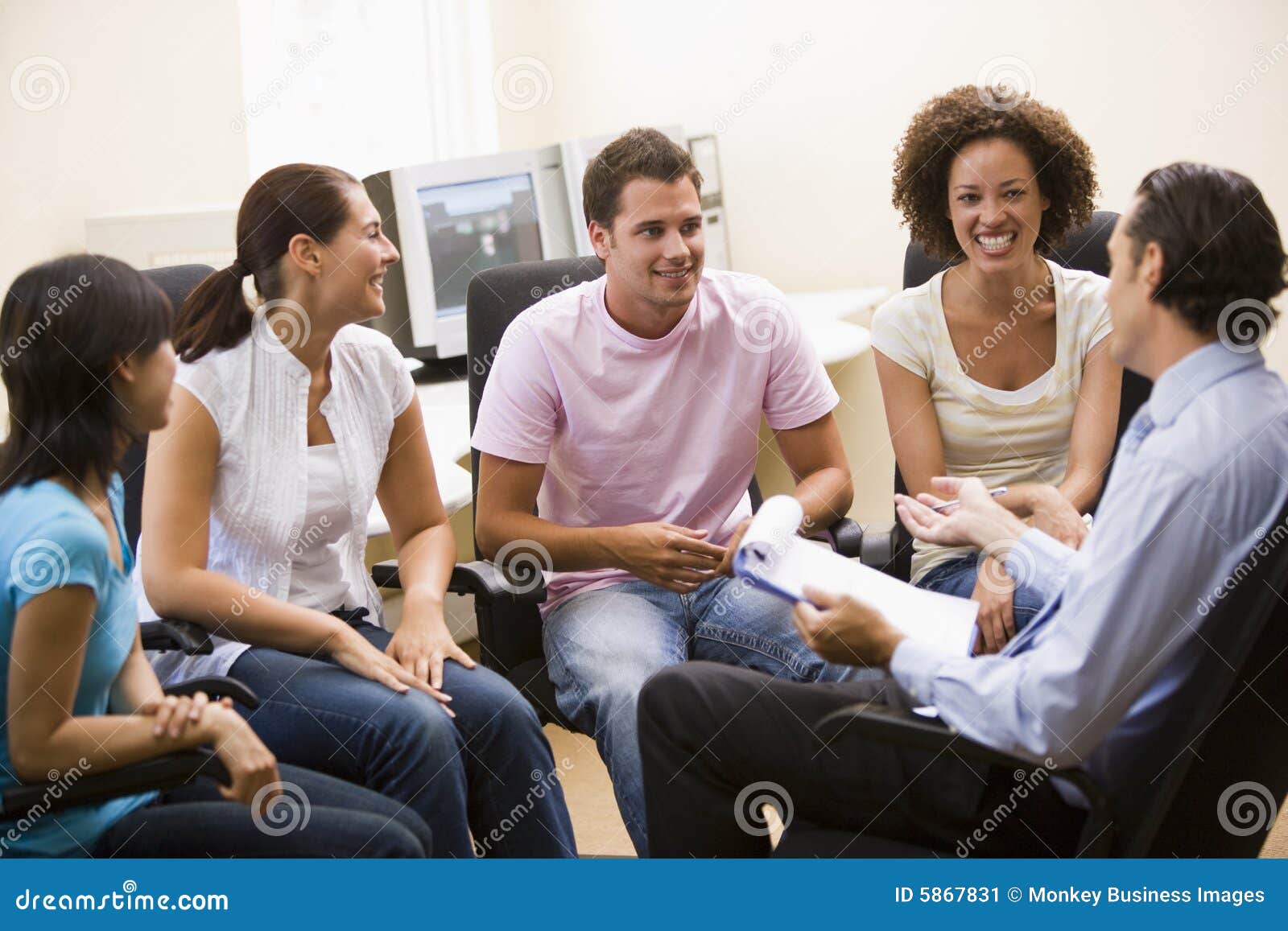 Man Giving Lecture To Four People in Computer Room Stock Image - Image ...