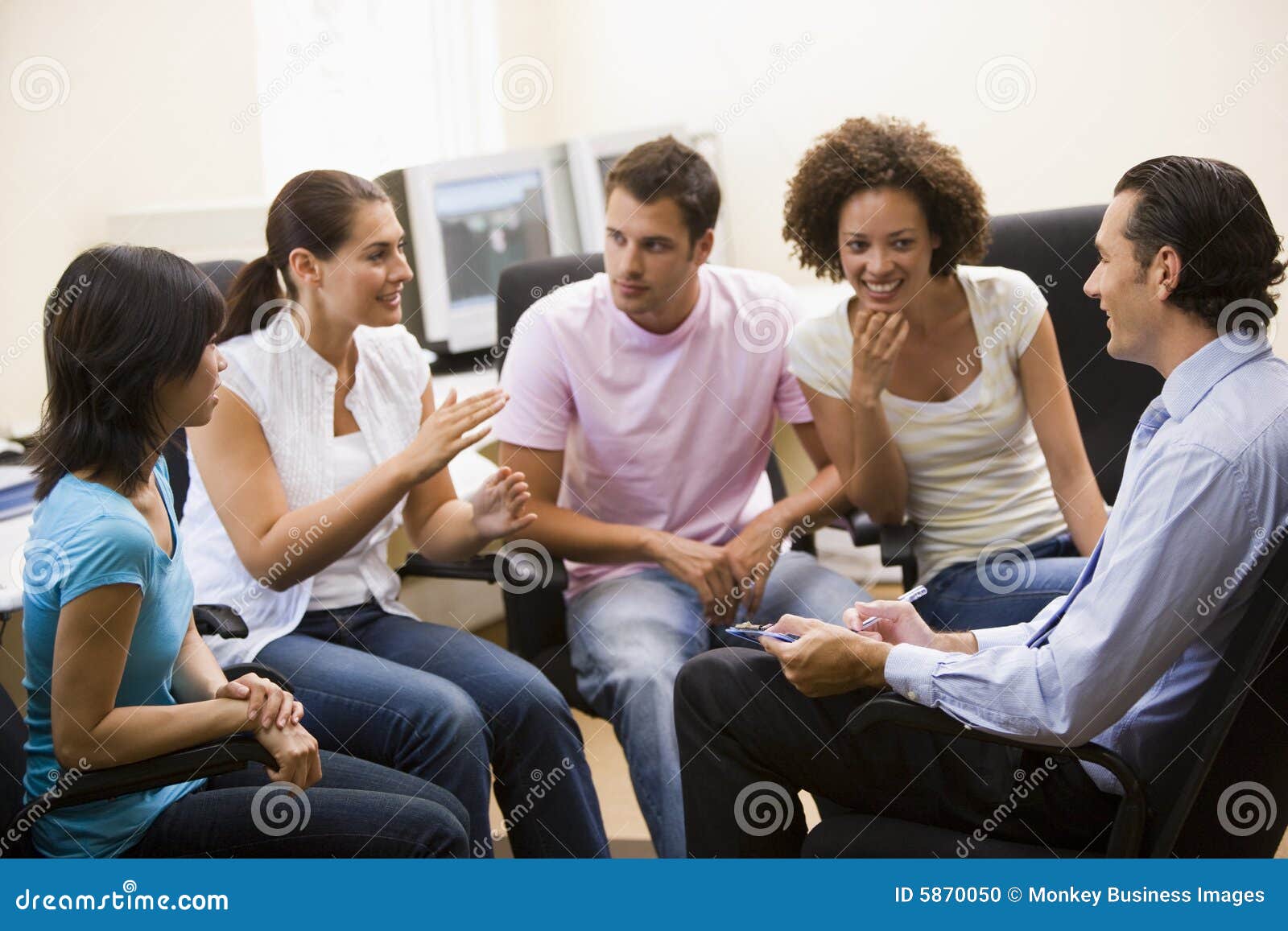 Man Giving Lecture To Four People in Computer Room Stock Photo - Image ...