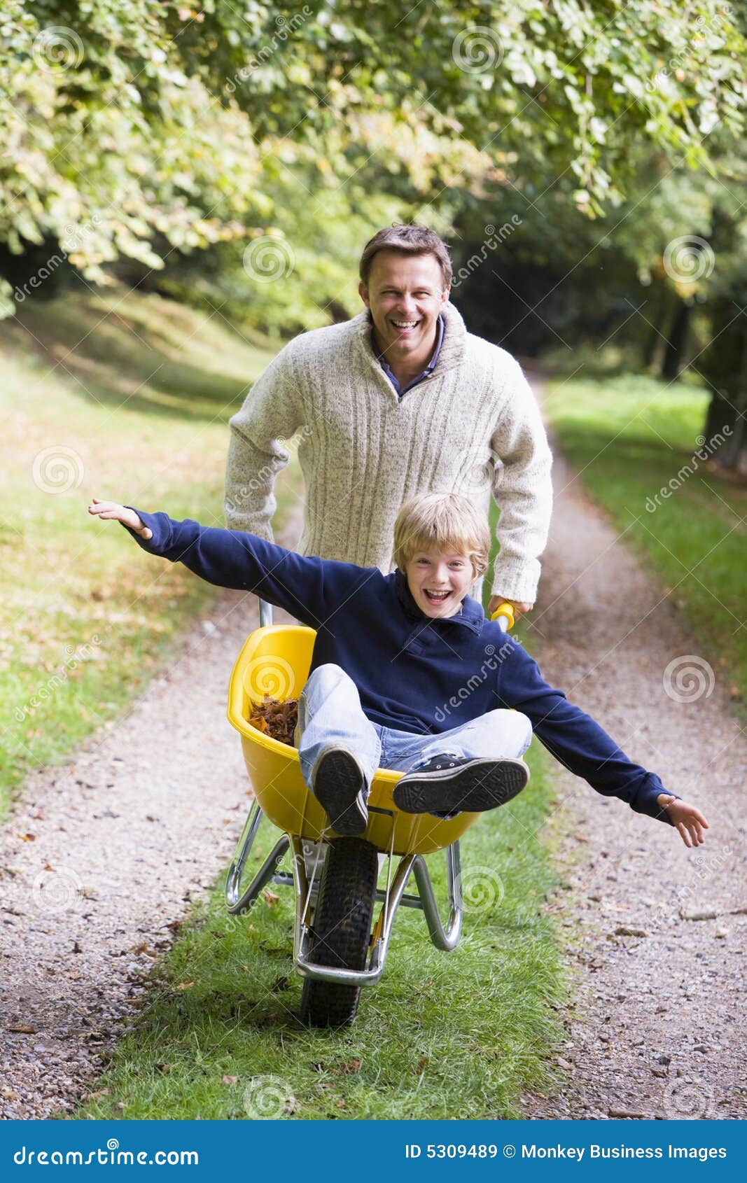 Man Giving Son Ride in Wheelbarrow Stock Image - Image of riding, ride ...