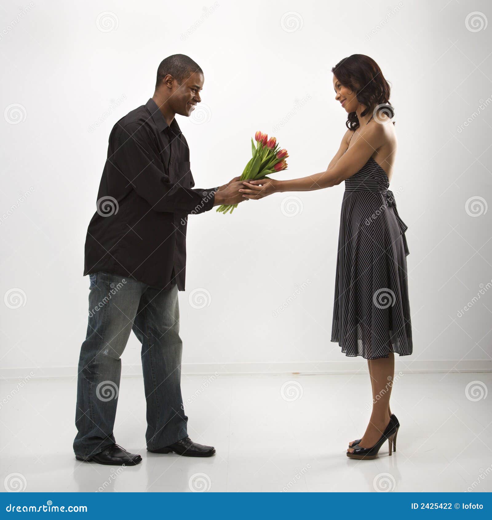 Man giving woman flowers. stock photo. Image of husband - 2425422