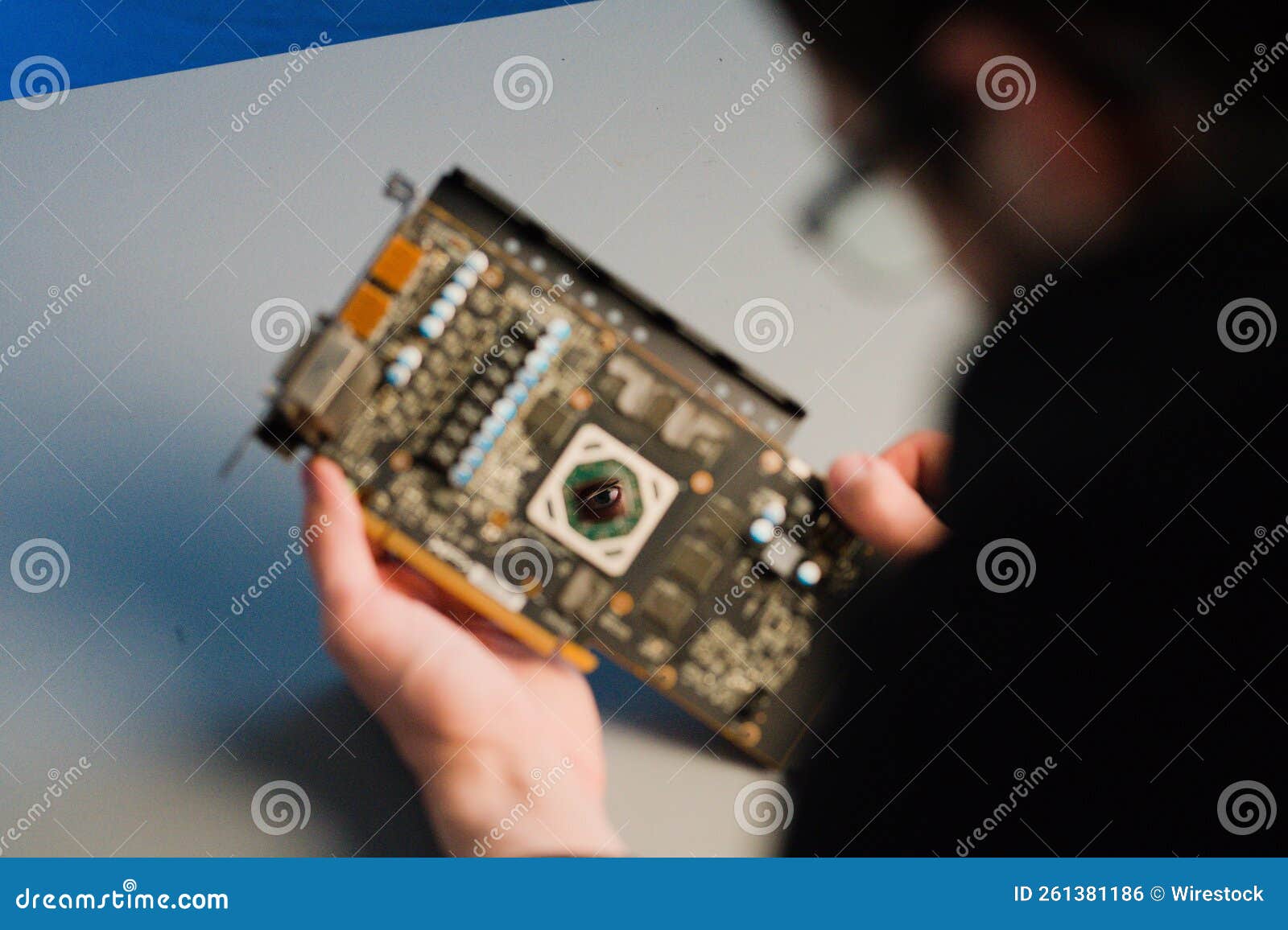 Man in Glasses Holding a Graphics Card GPU AMD with His Eye Reflected ...