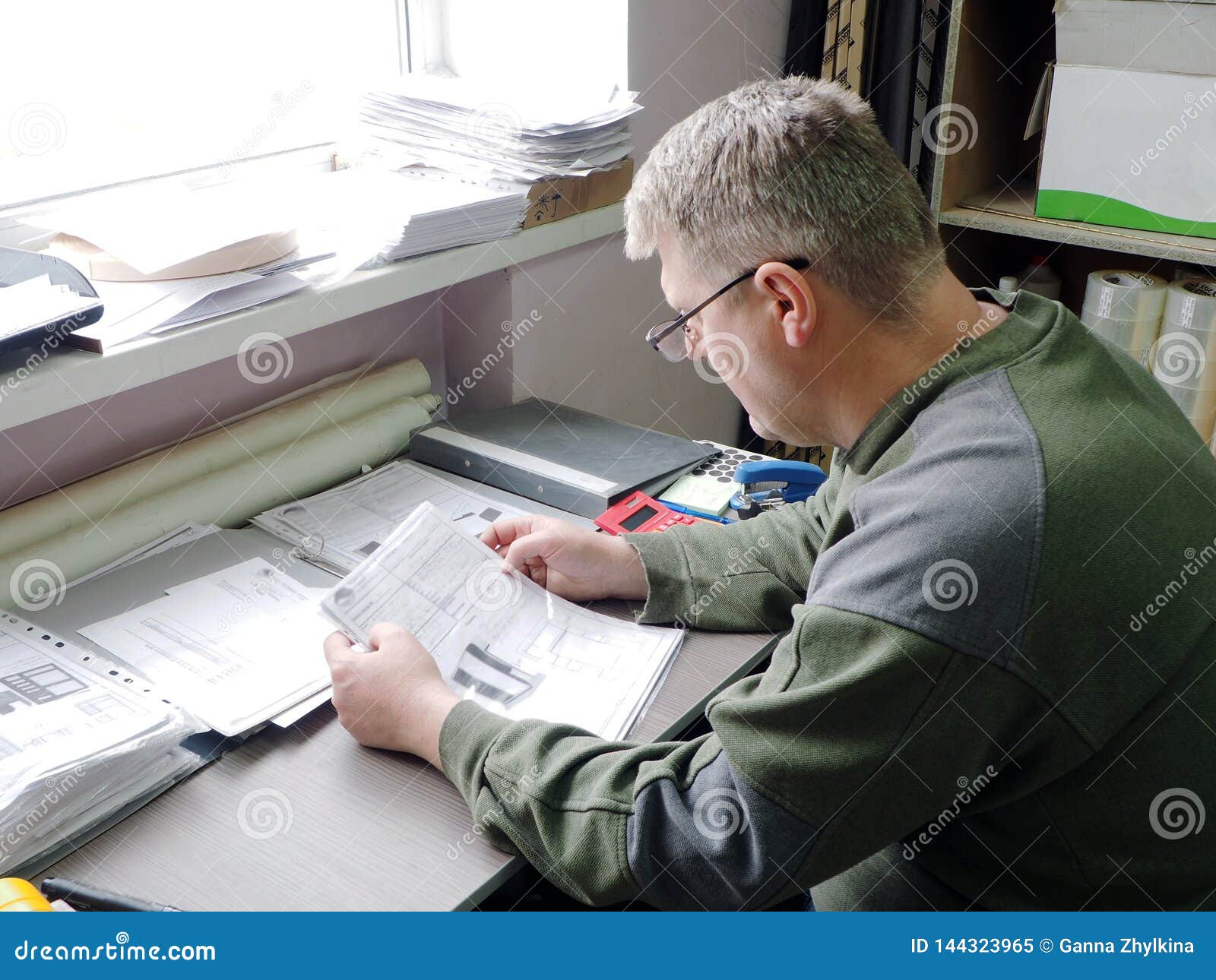 Man Looking at Paper in Glasses Stock Image - Image of sitting, view ...