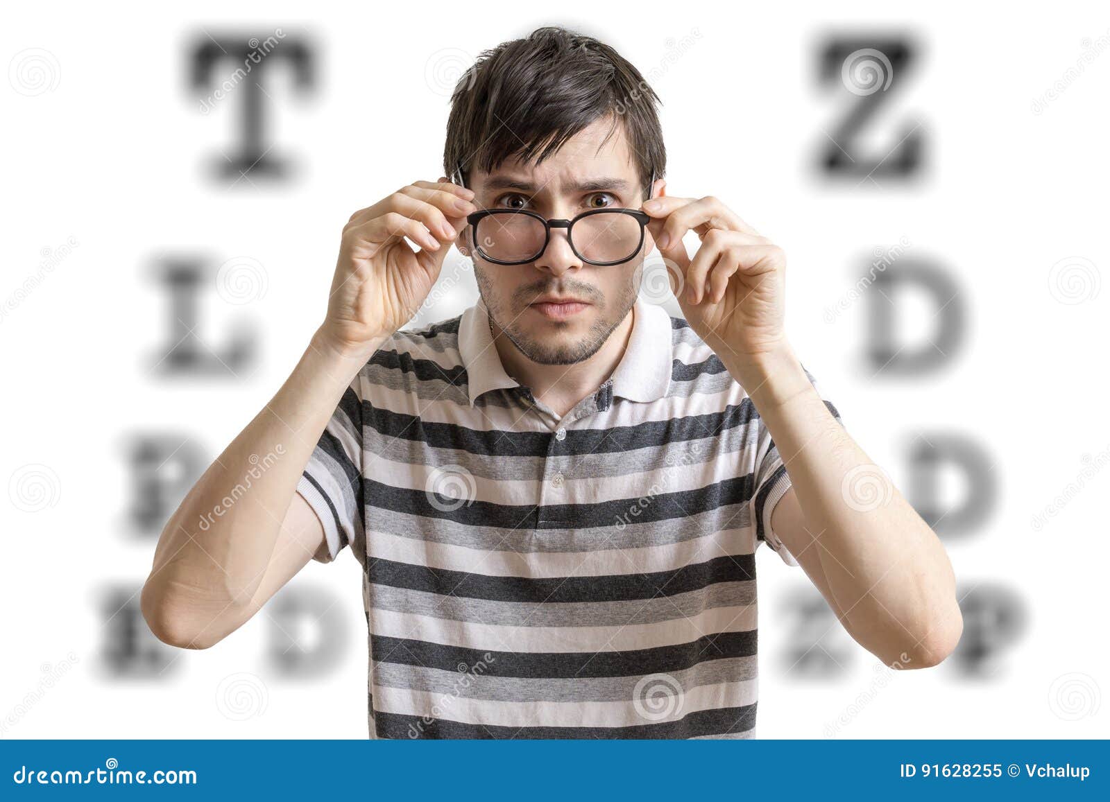 Man with Glasses is Testing His Sight. Chart for Eye Sight Testing in ...
