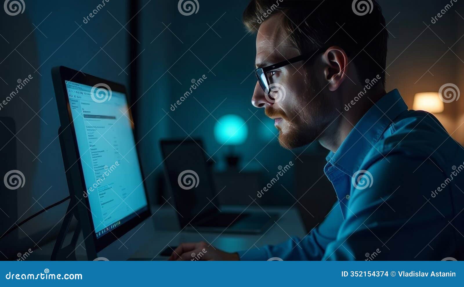 Man in Glasses Working on Computer in Dark Room Stock Photo - Image of ...