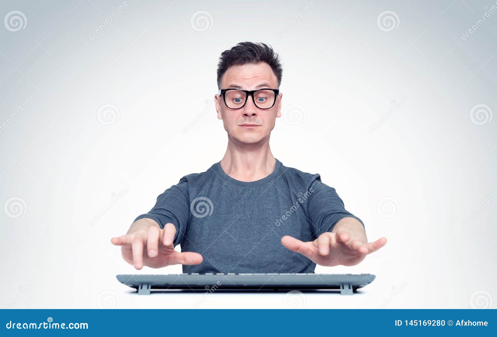 Man in Glasses Working at the Computer, His Hands Hover Over the ...