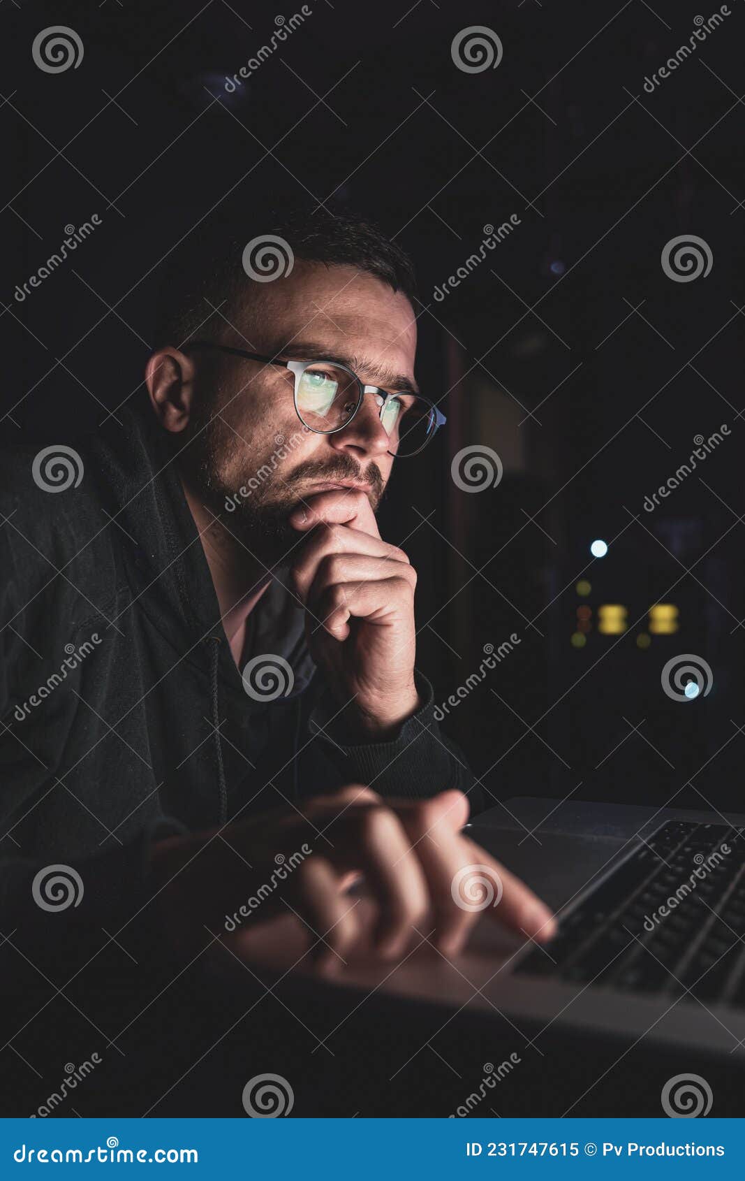 A Man with Glasses Works at a Computer Late at Night Stock Image ...