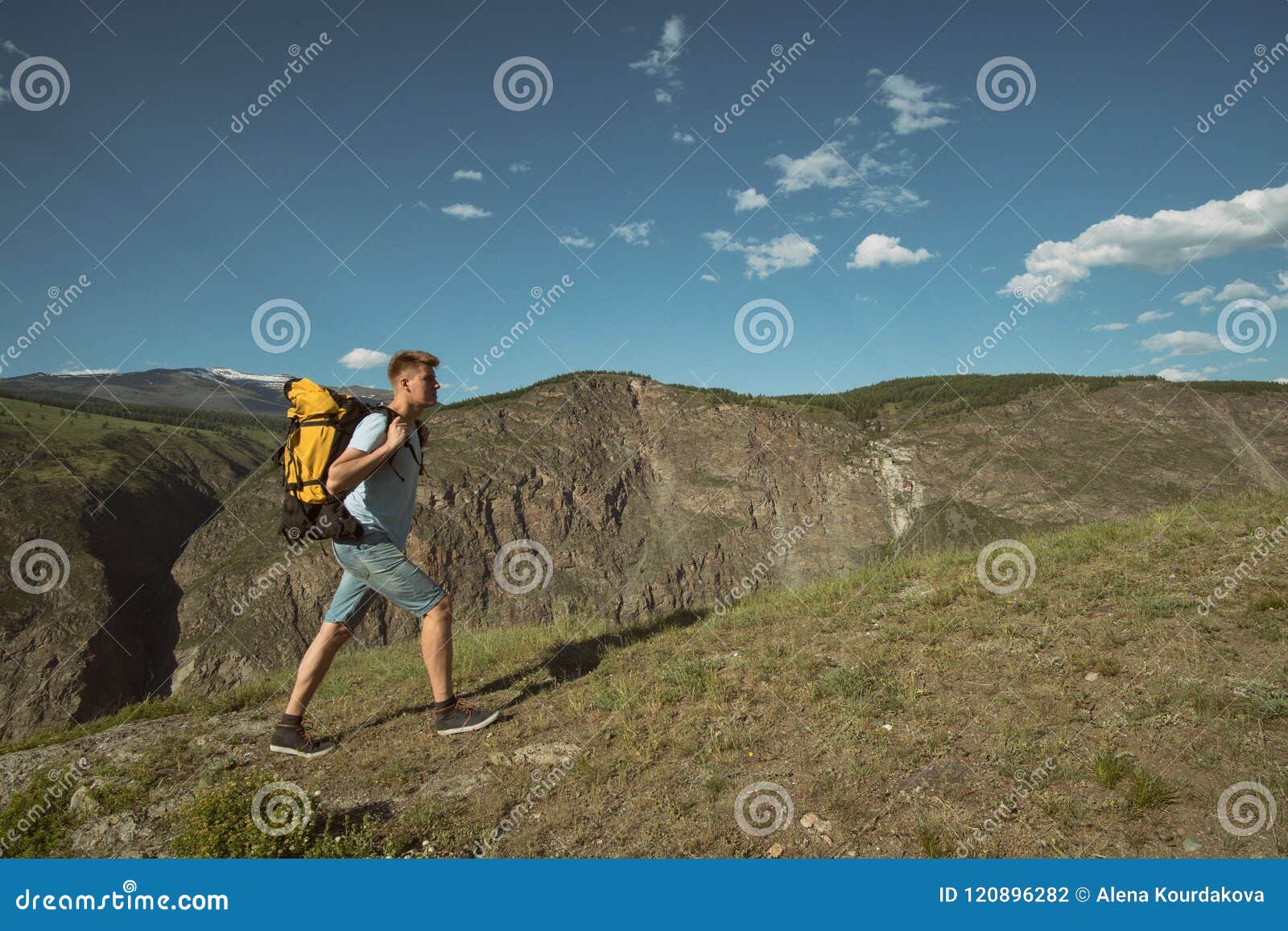 Man Goes Uphill with a Backpack on His Back Stock Photo - Image of side ...