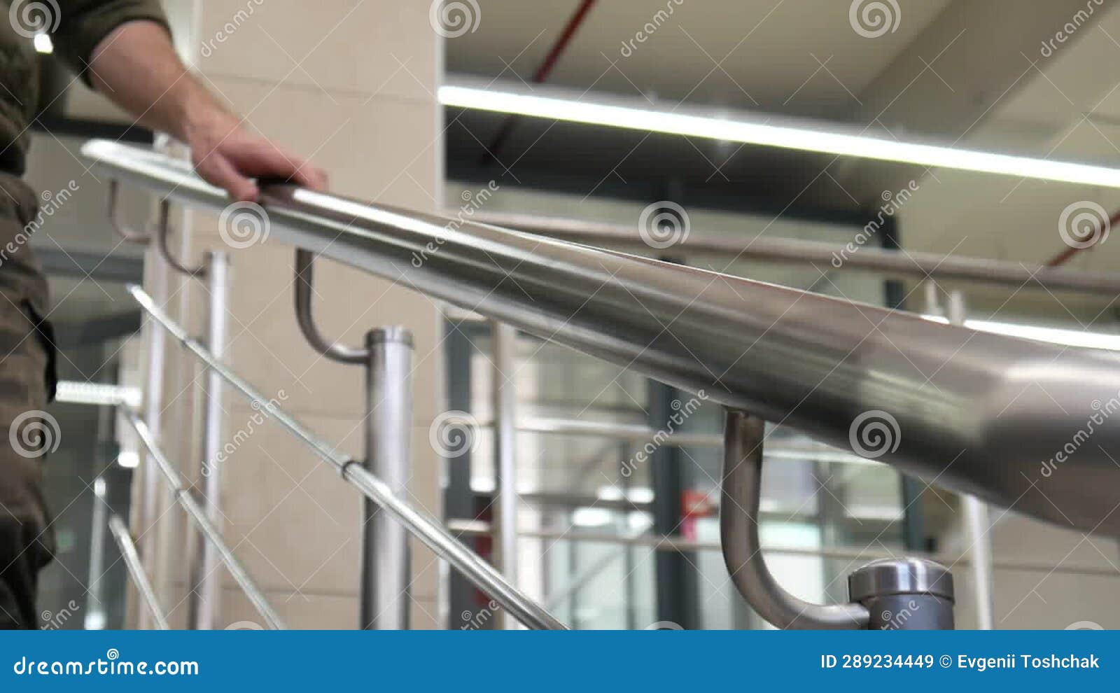 A Man Going Down the Stairs Holding on To a Handrail Close-up Stock ...