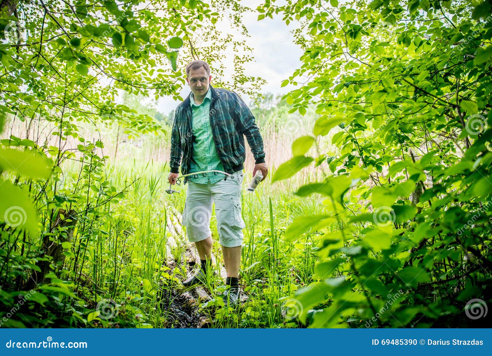 Man going through forest stock photo. Image of fisherman - 69485390