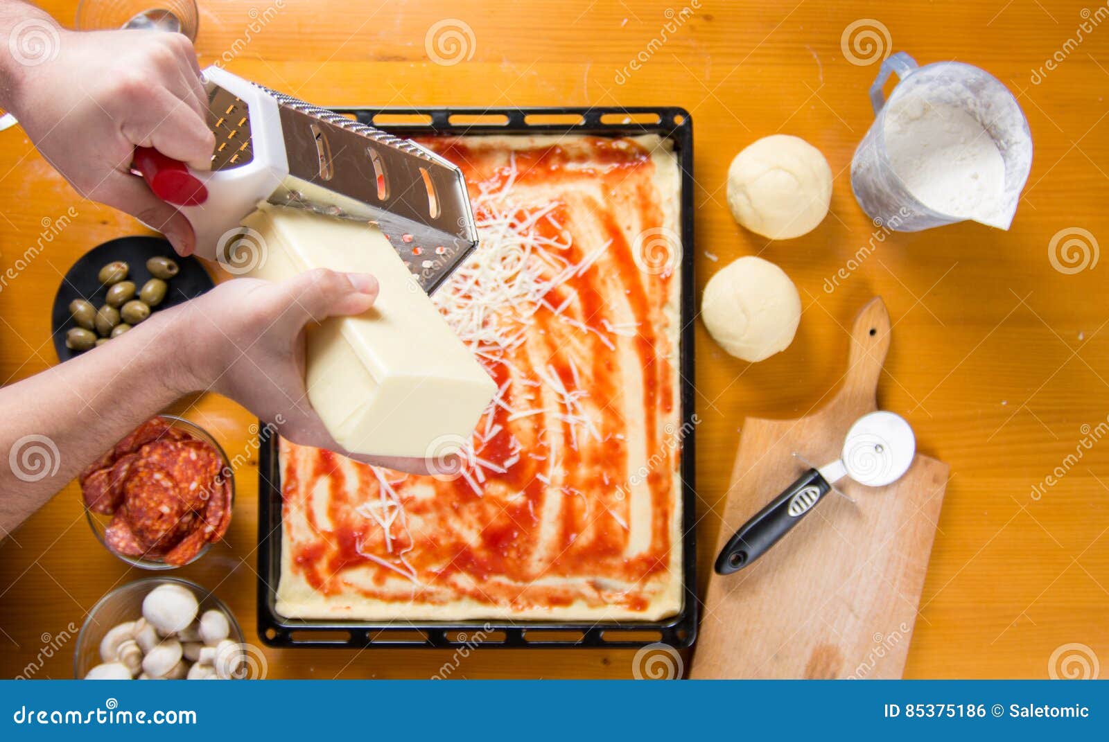 Man Grating Cheese on Pizza Base Stock Photo - Image of kitchen ...