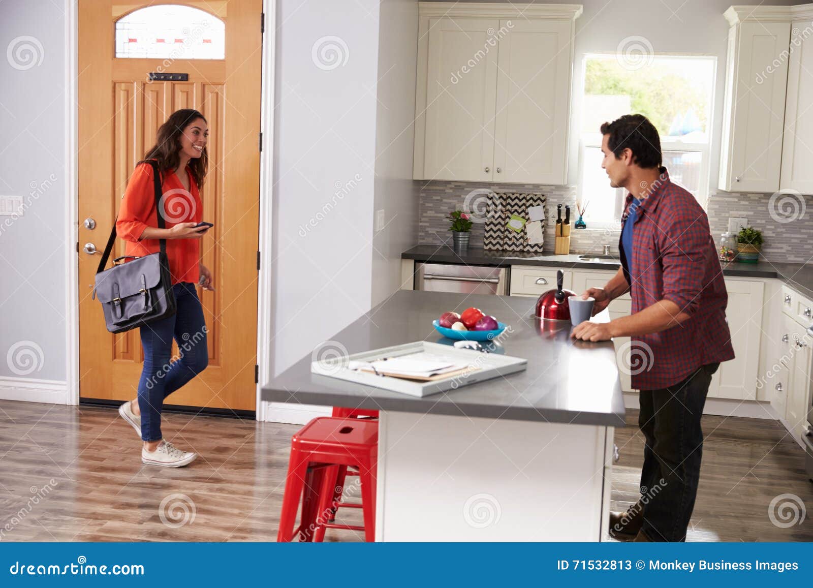 Man Greeting Woman Returning Home from Work Stock Image - Image of ...