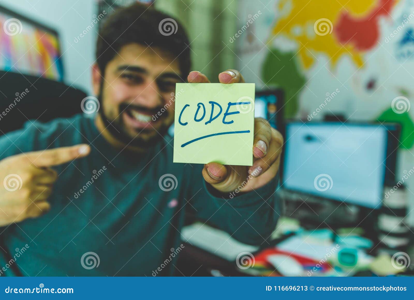 Man In Grey Sweater Holding Yellow Sticky Note Picture. Image: 116696213