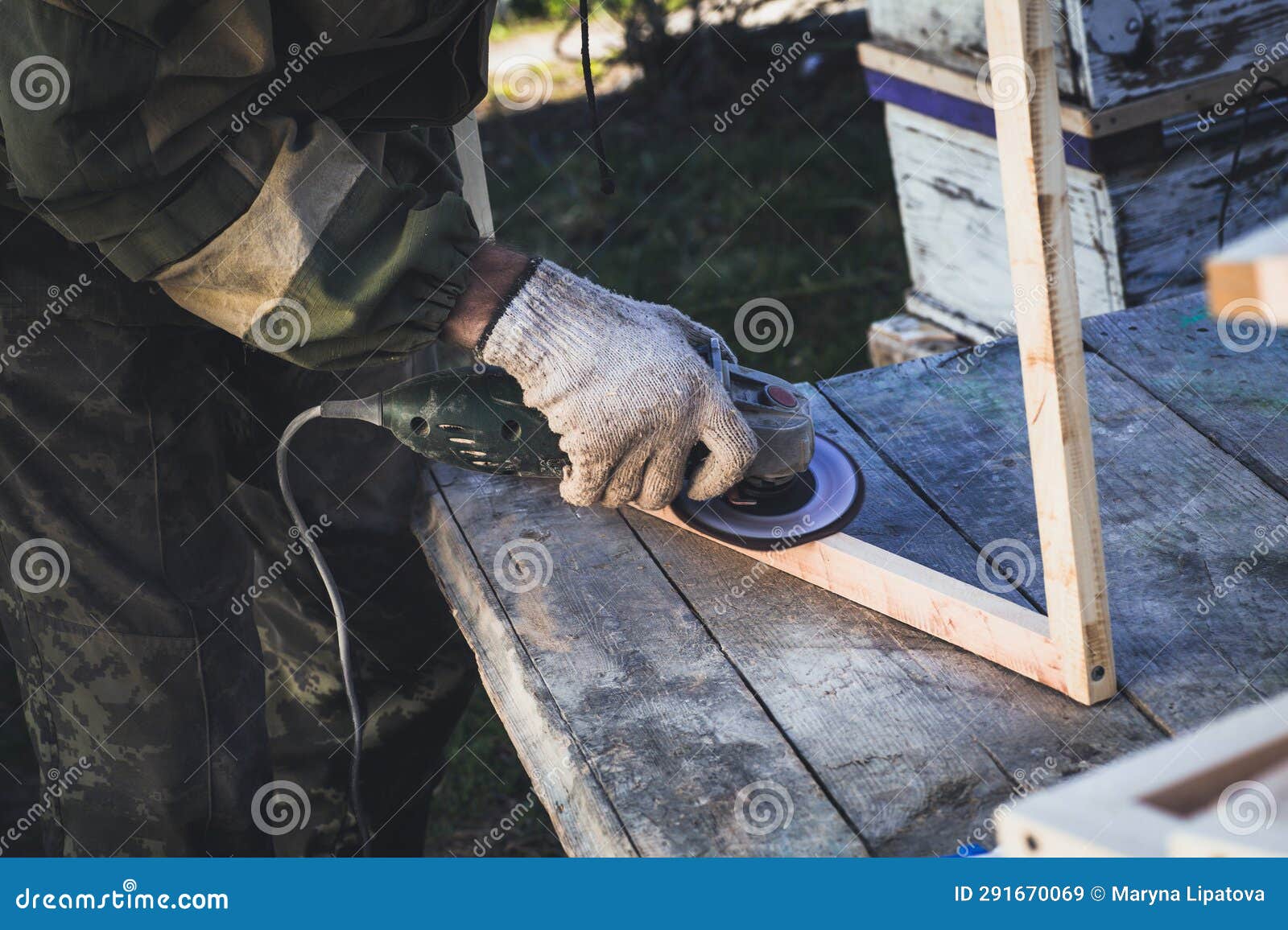 Man with Grinding Machine Makes Frame for Bees. Create Bee Frame with ...