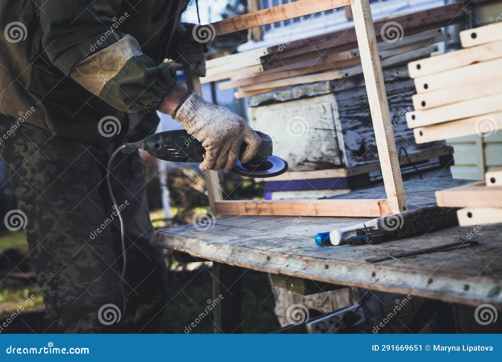 Man with Grinding Machine Makes Frame for Bees. Create Bee Frame with ...