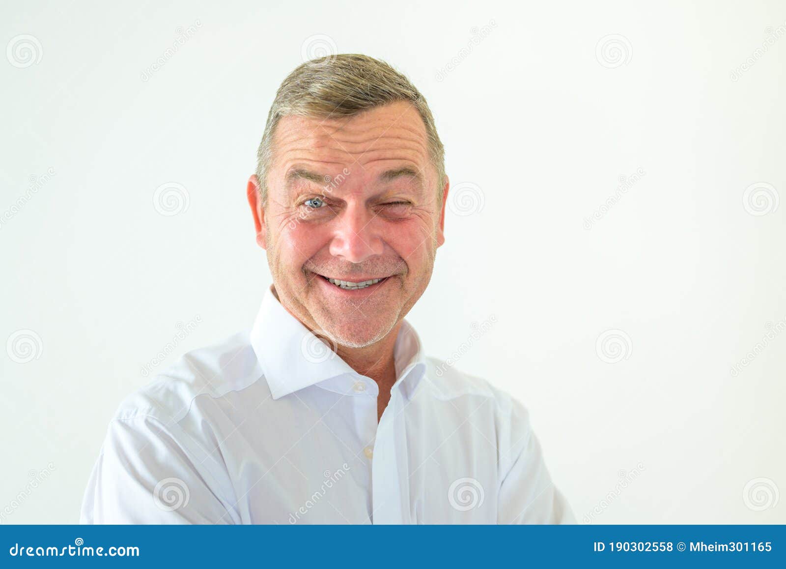 Man Grinning with Glee and Winking at the Camera Stock Photo - Image of ...