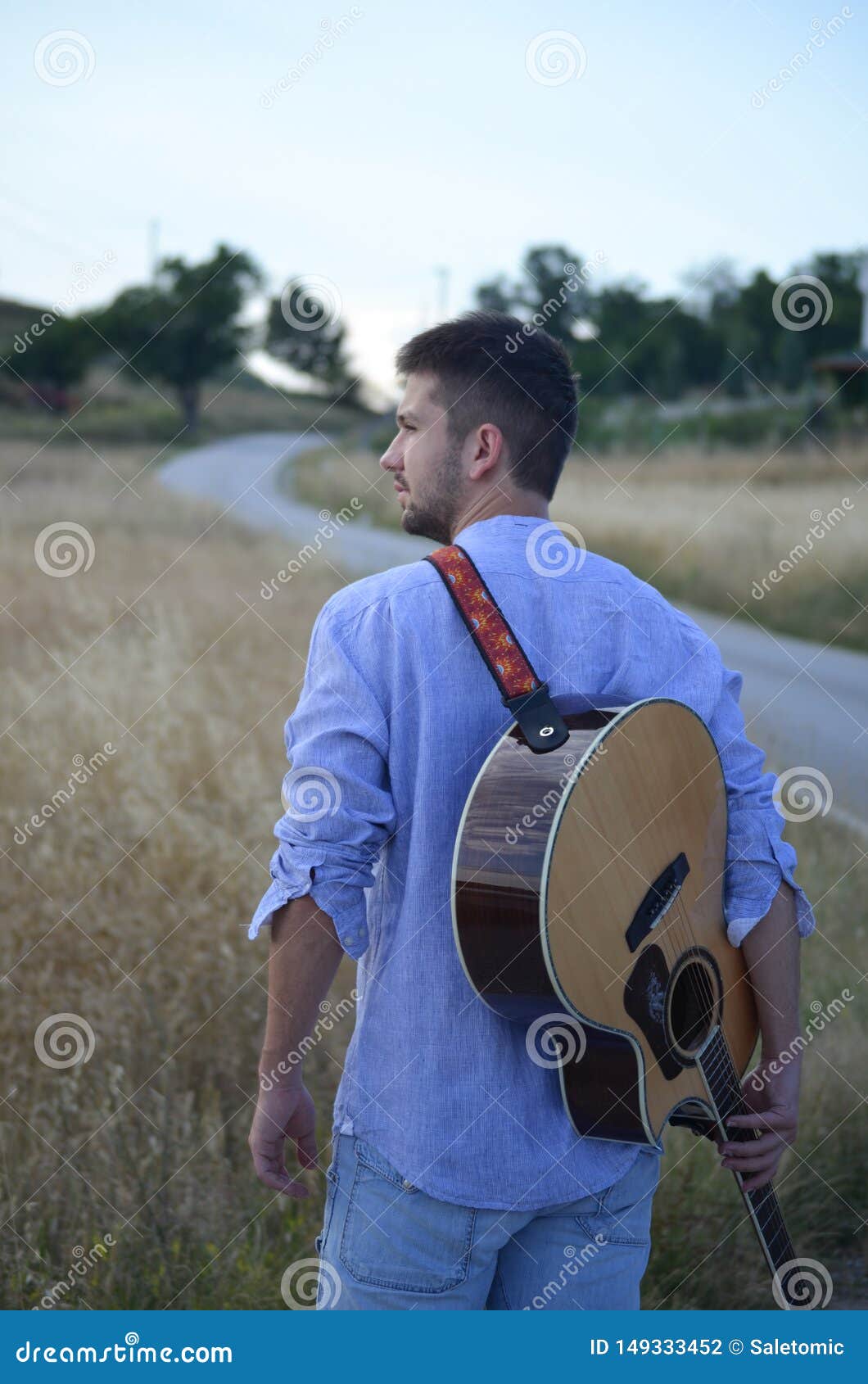 Man with a Guitar Hanging from His Back Stock Photo - Image of person ...