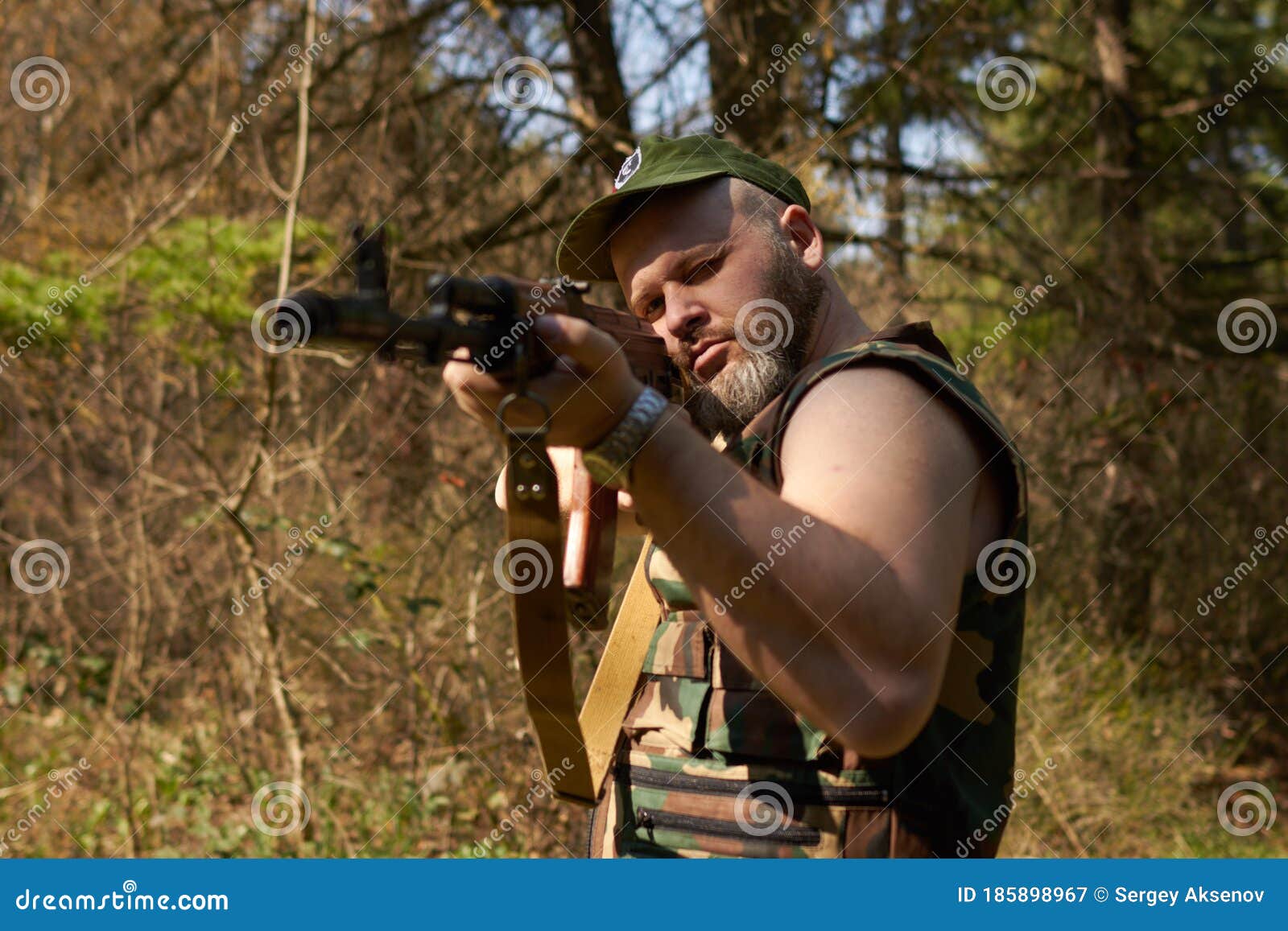 A Man with a Gun in a Forest Stock Image - Image of practicing, forest ...