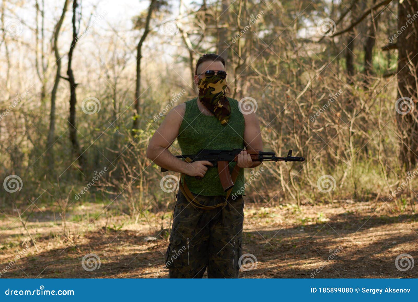 A Man with a Gun in a Forest Stock Photo - Image of aiming, prey: 185899080