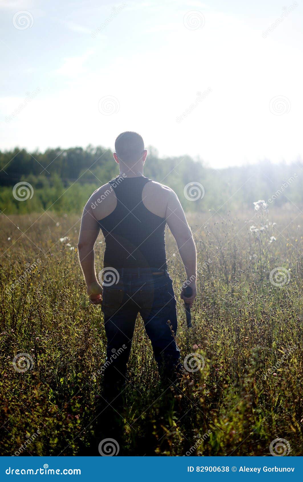 A Man with a Gun in His Hands.Back View Stock Photo - Image of snaper ...