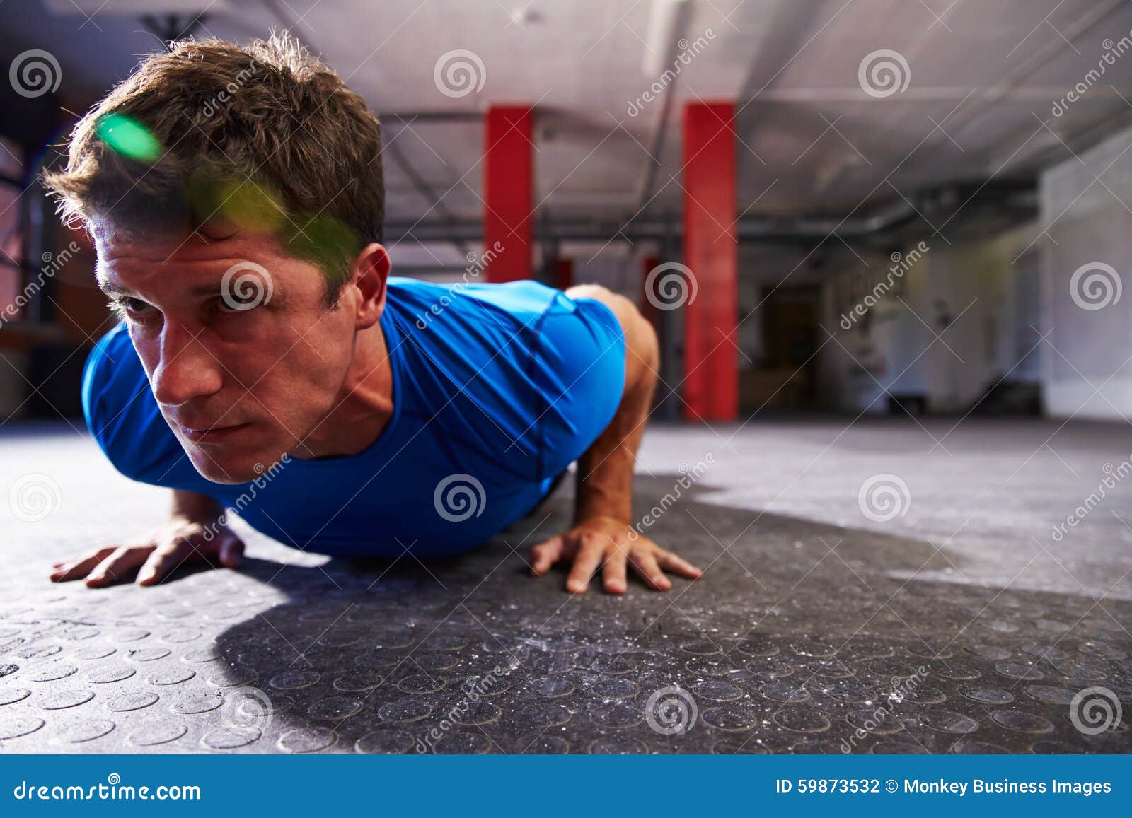 Man in Gym Doing Press-Ups stock photo. Image of building - 59873532