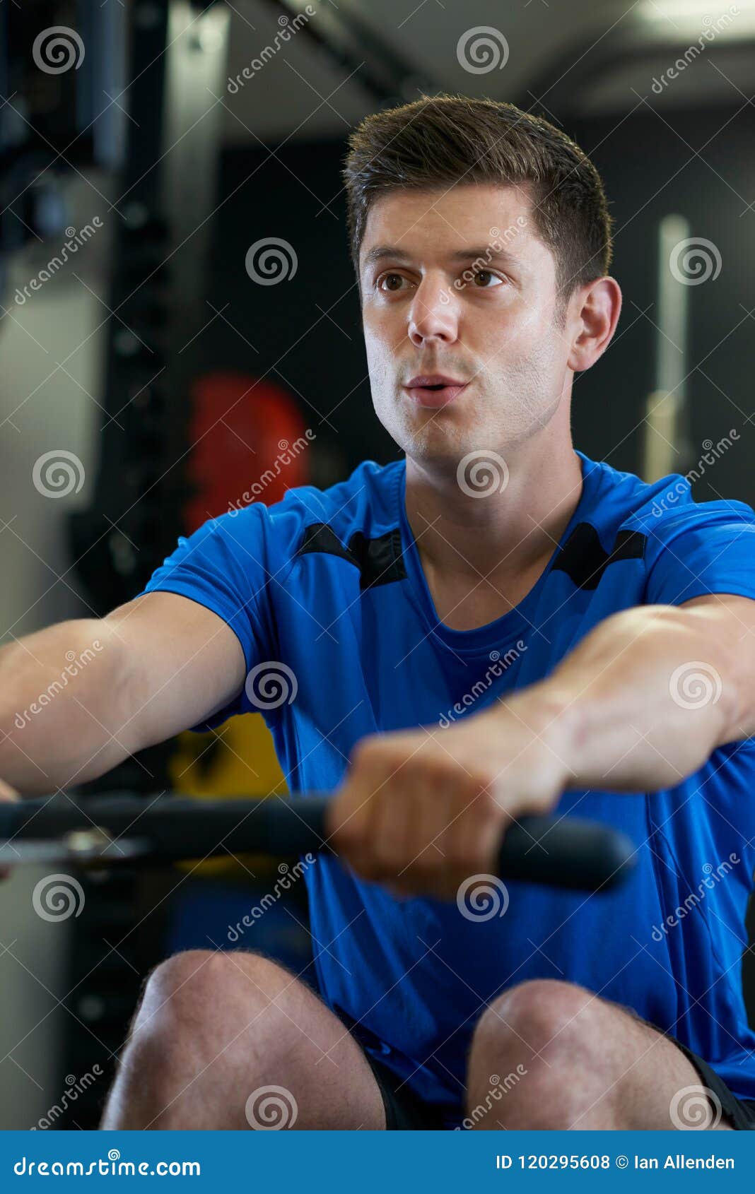 Man in Gym Exercising on Rowing Machine Stock Photo - Image of rowing ...