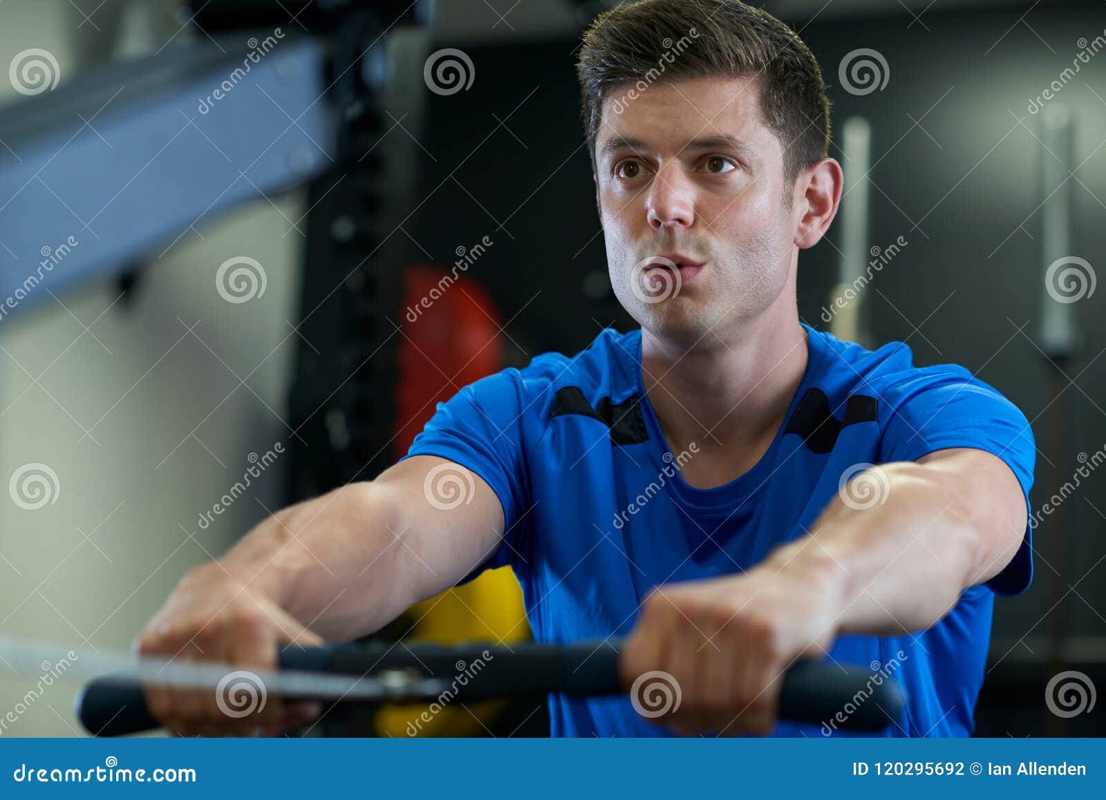 Man in Gym Exercising on Rowing Machine Stock Photo - Image of thirties ...