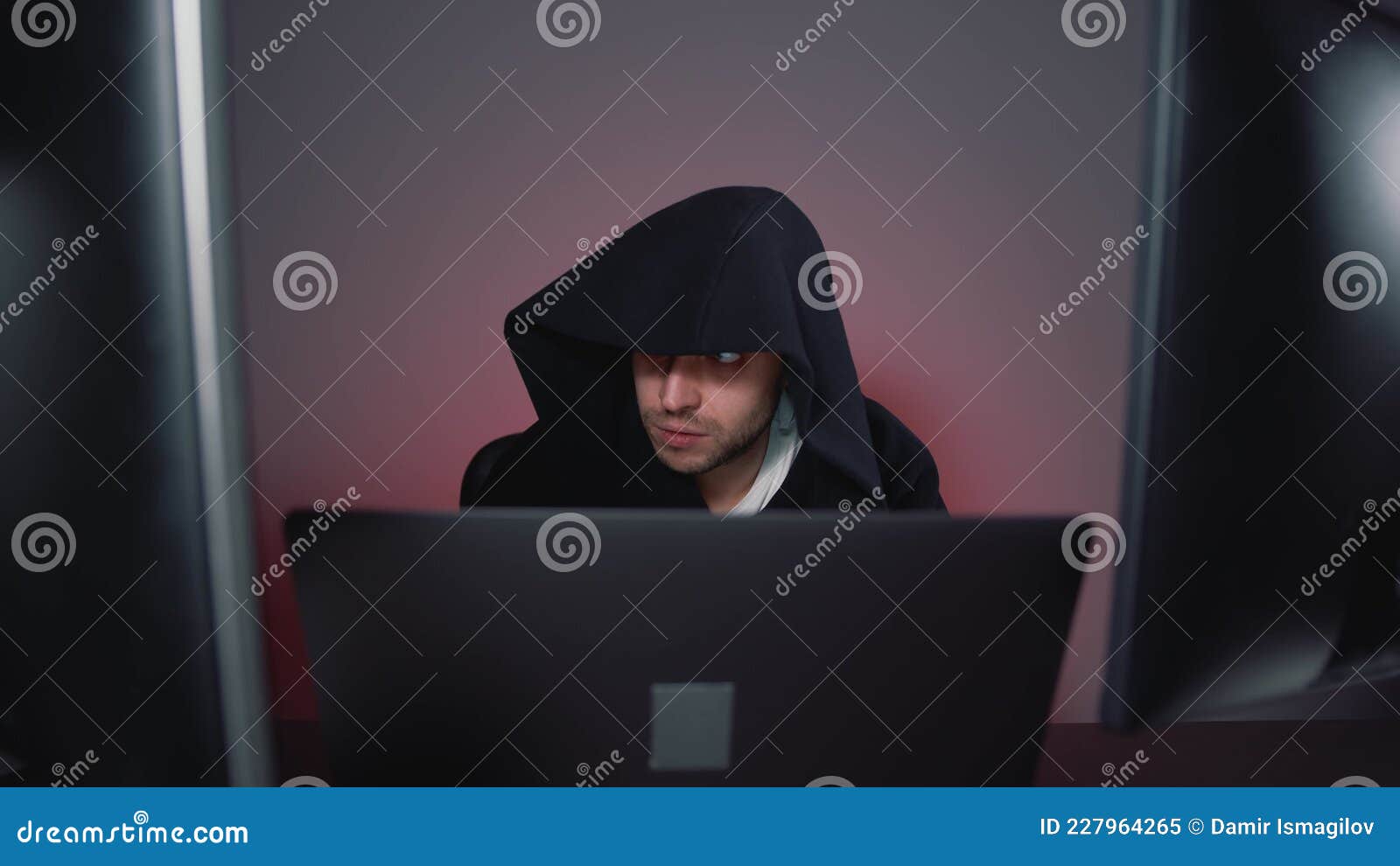 Man Hacker in Black Hood, Working with Several Computers Evil Smile ...