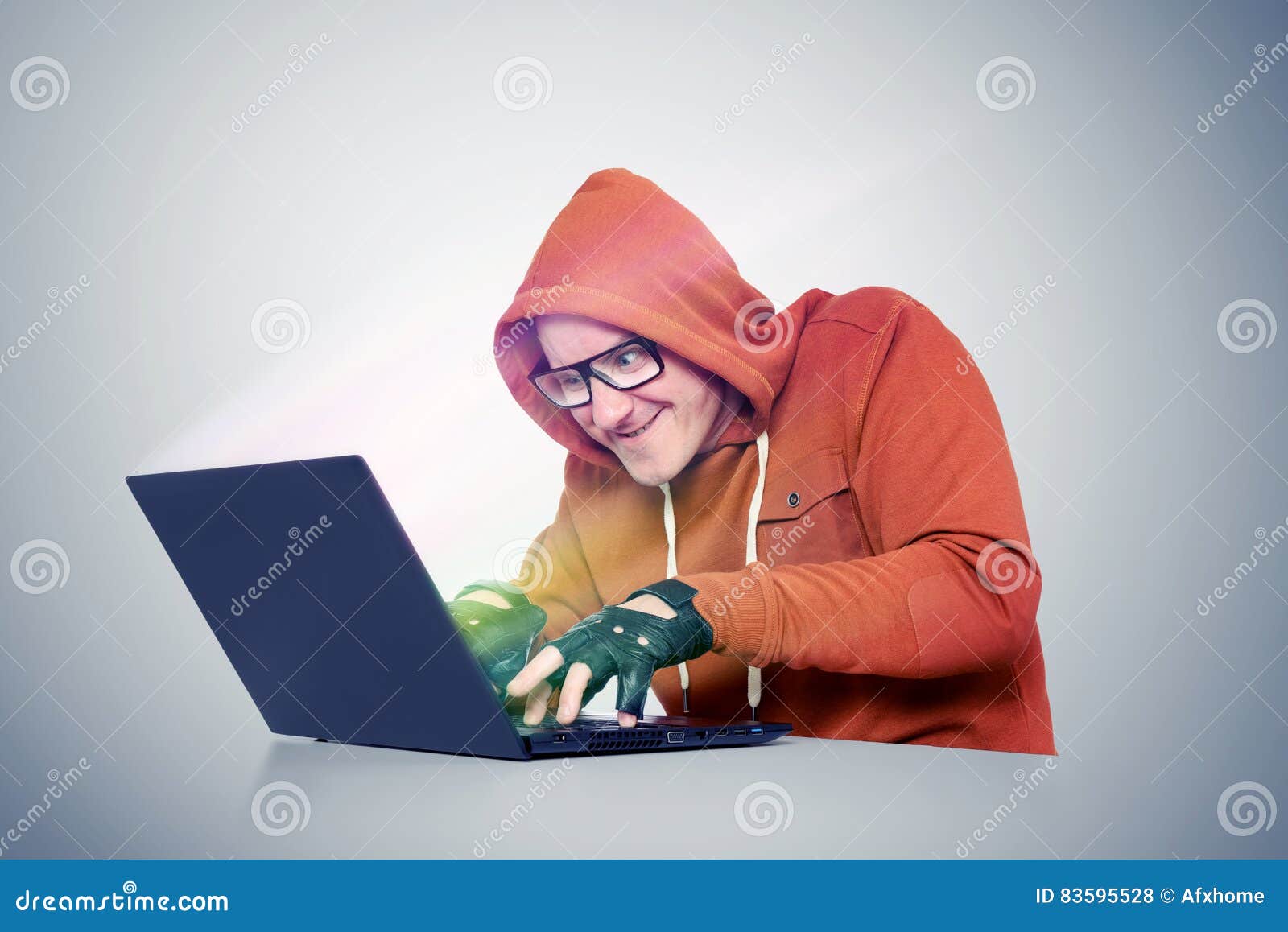 Man Hacker in Glasses with a Laptop. Cybercrime Concept Stock Photo ...