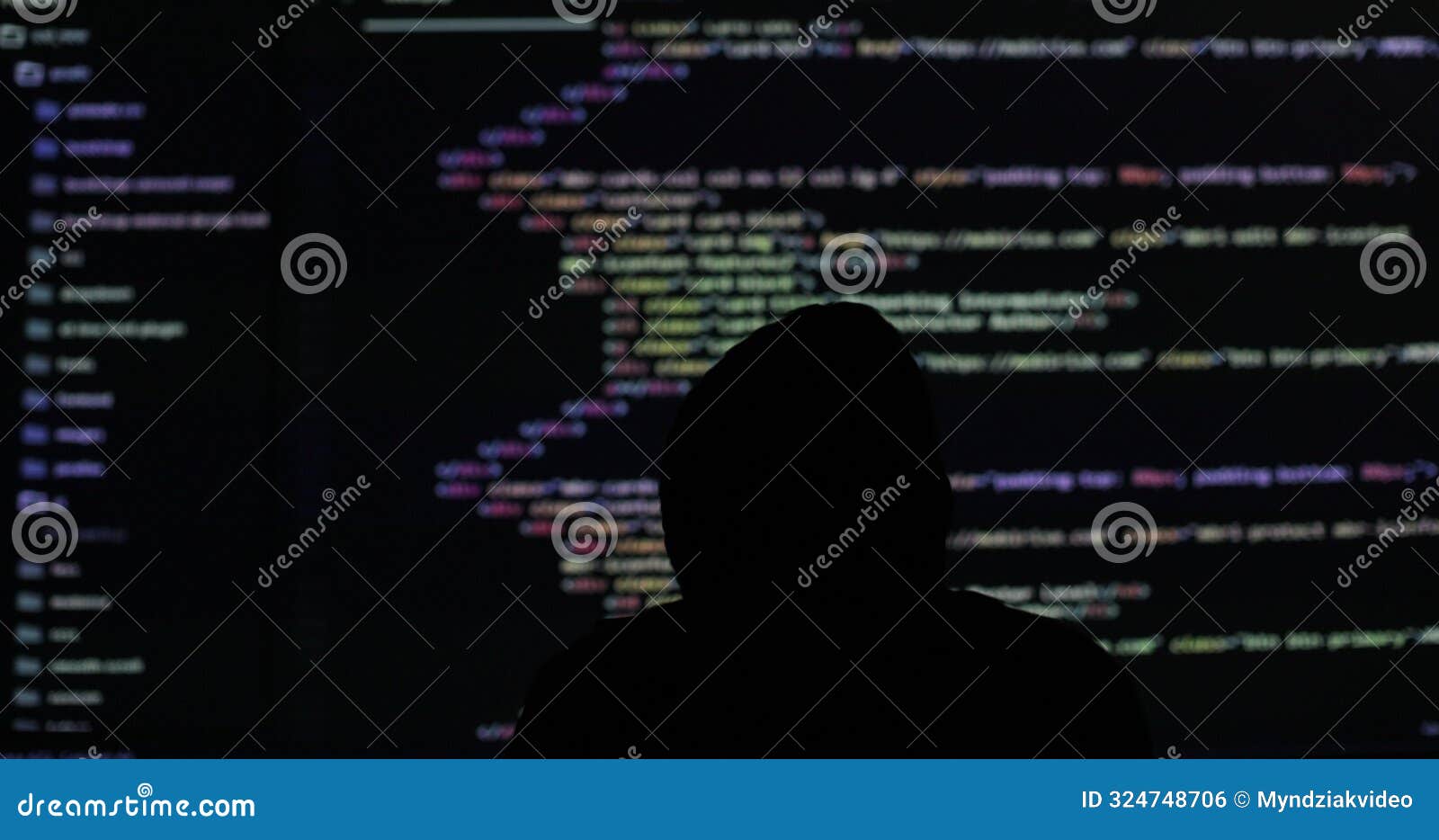 Man Hacker Working In Dark Abstract Room Programming Code On A Large Screen In The Background