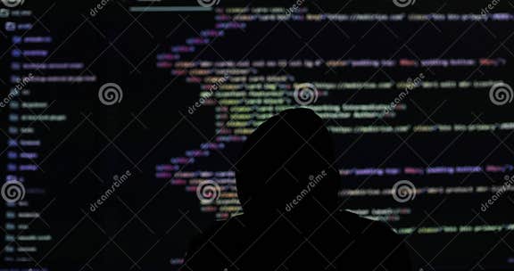 Man Hacker Working In Dark Abstract Room Programming Code On A Large